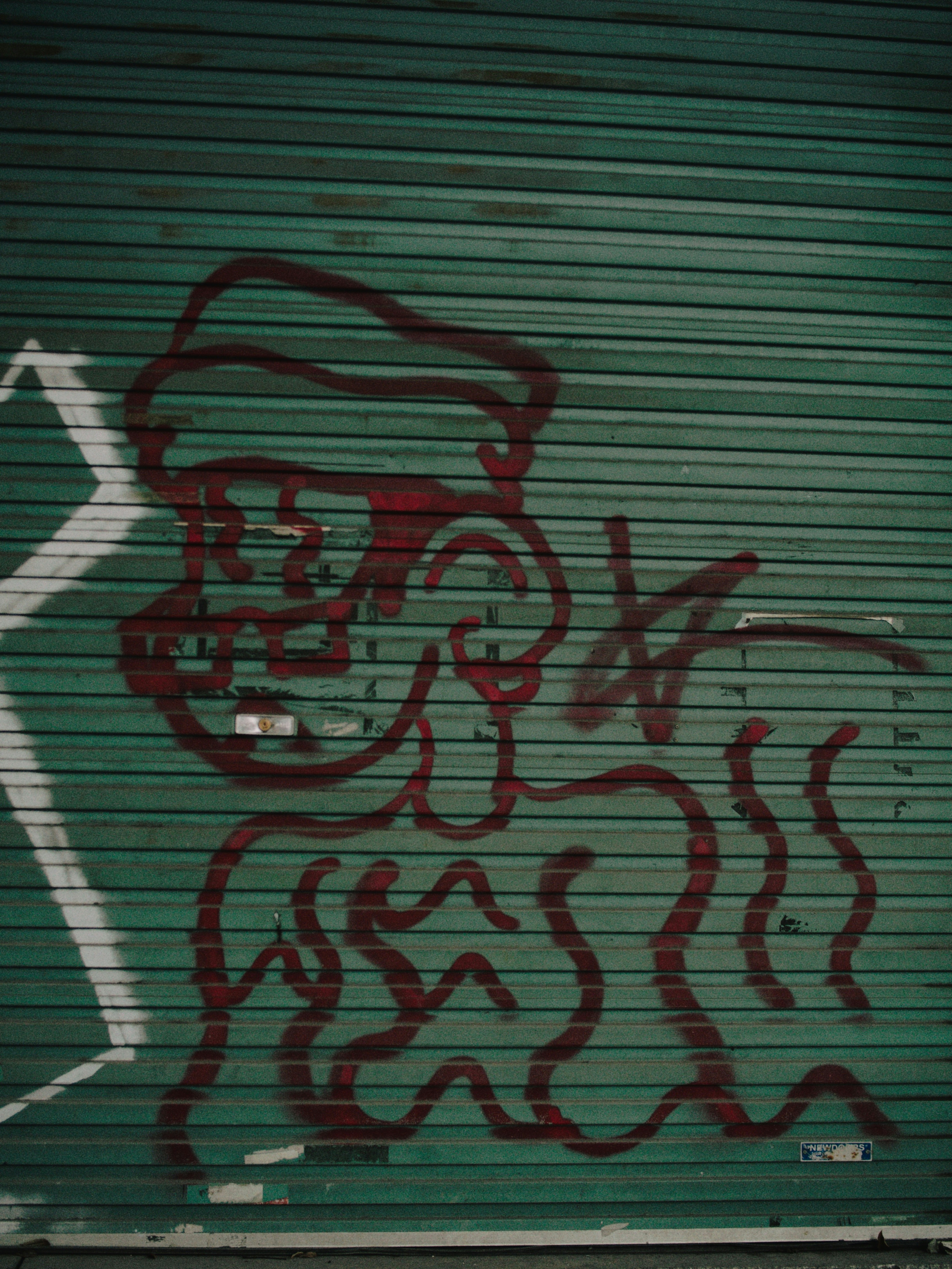 Red Ranger on Green Corrugated: A Bold Graffiti Portrait