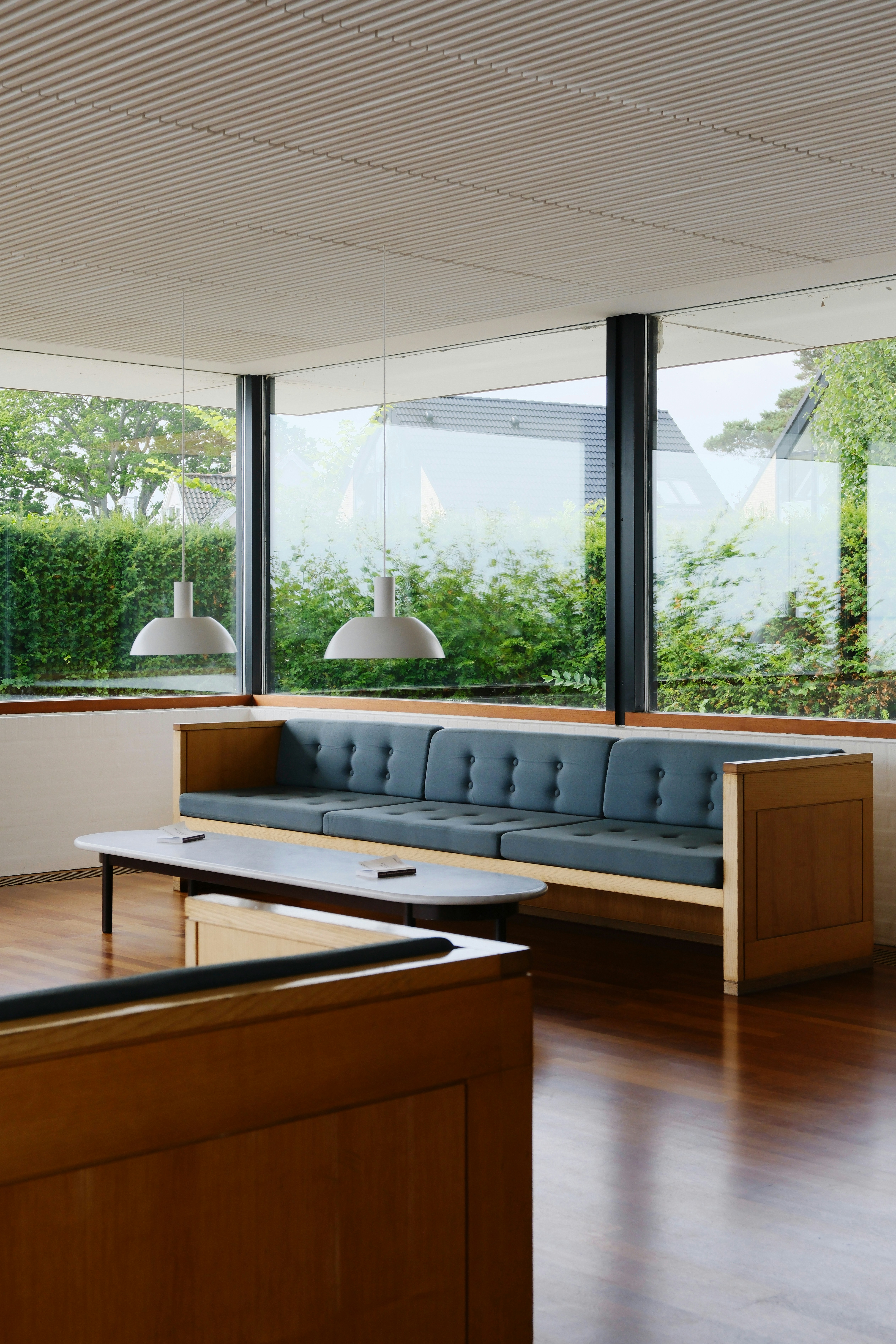 Sunlit Lounge: Modern Booths and Glass Walls in a Quiet Office Atrium