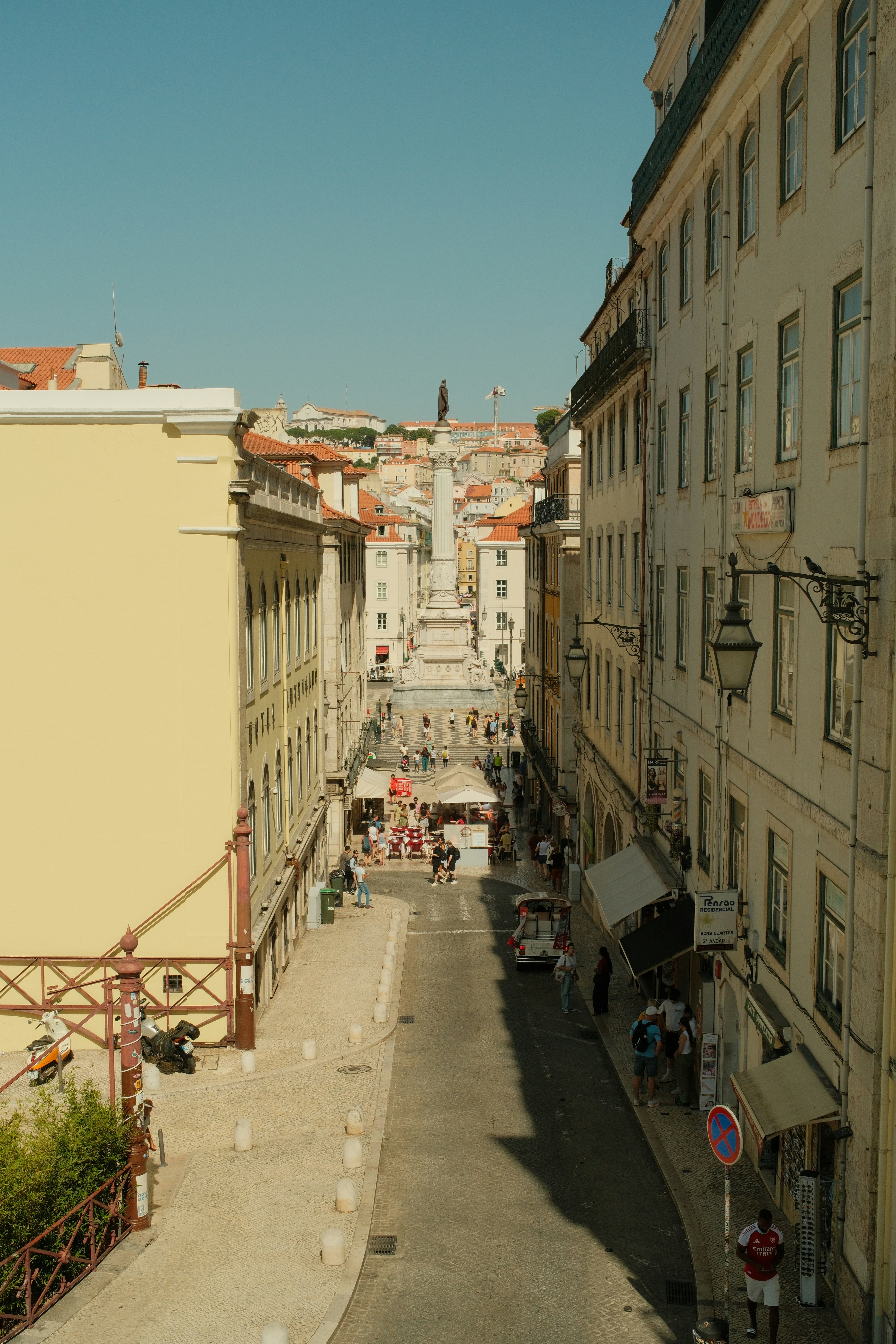 Lisbon-like stairway downward toward a bustling European street