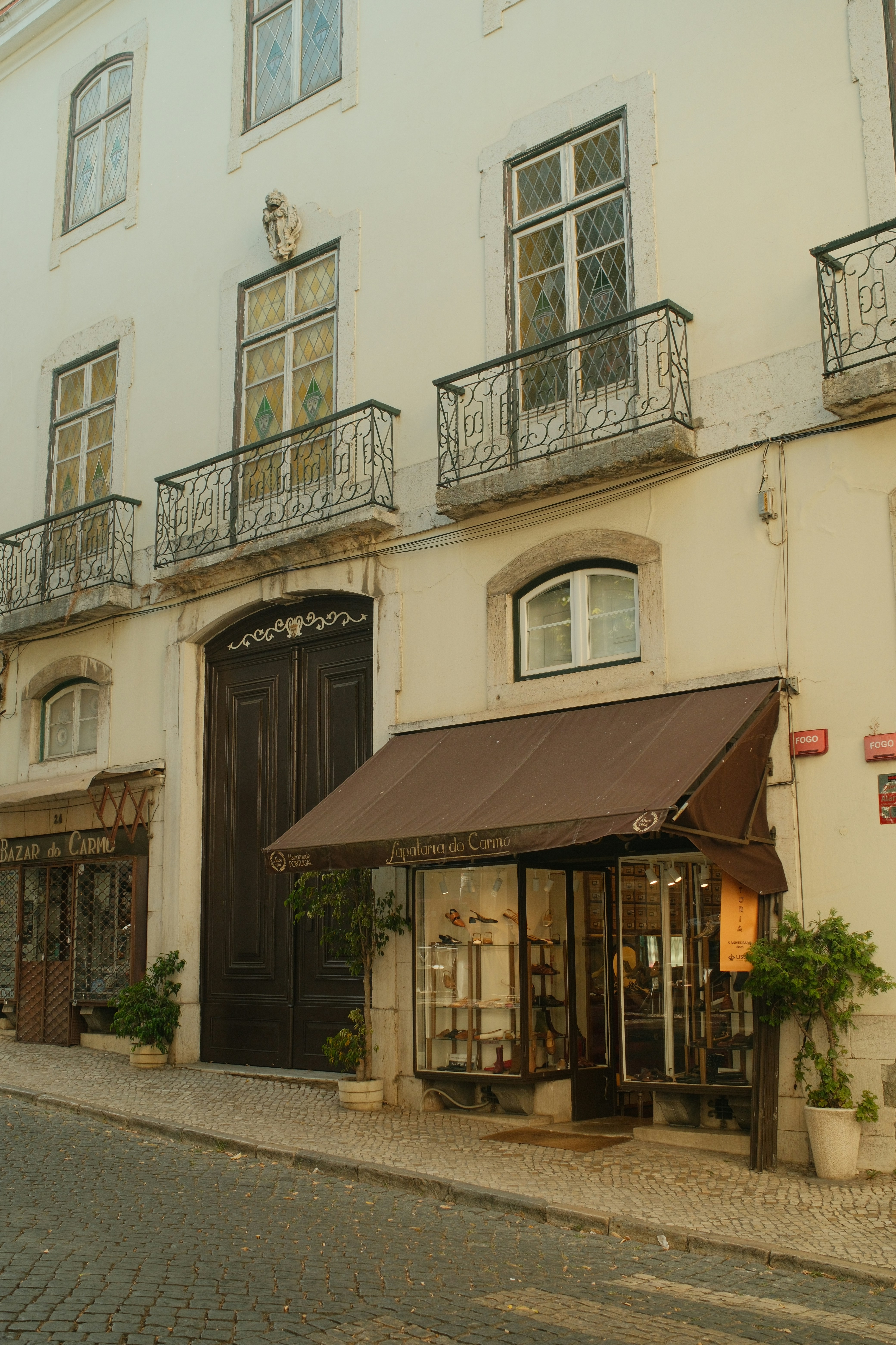 Facade of a Sunlit Plazaside Shop with Ornate Balconyes