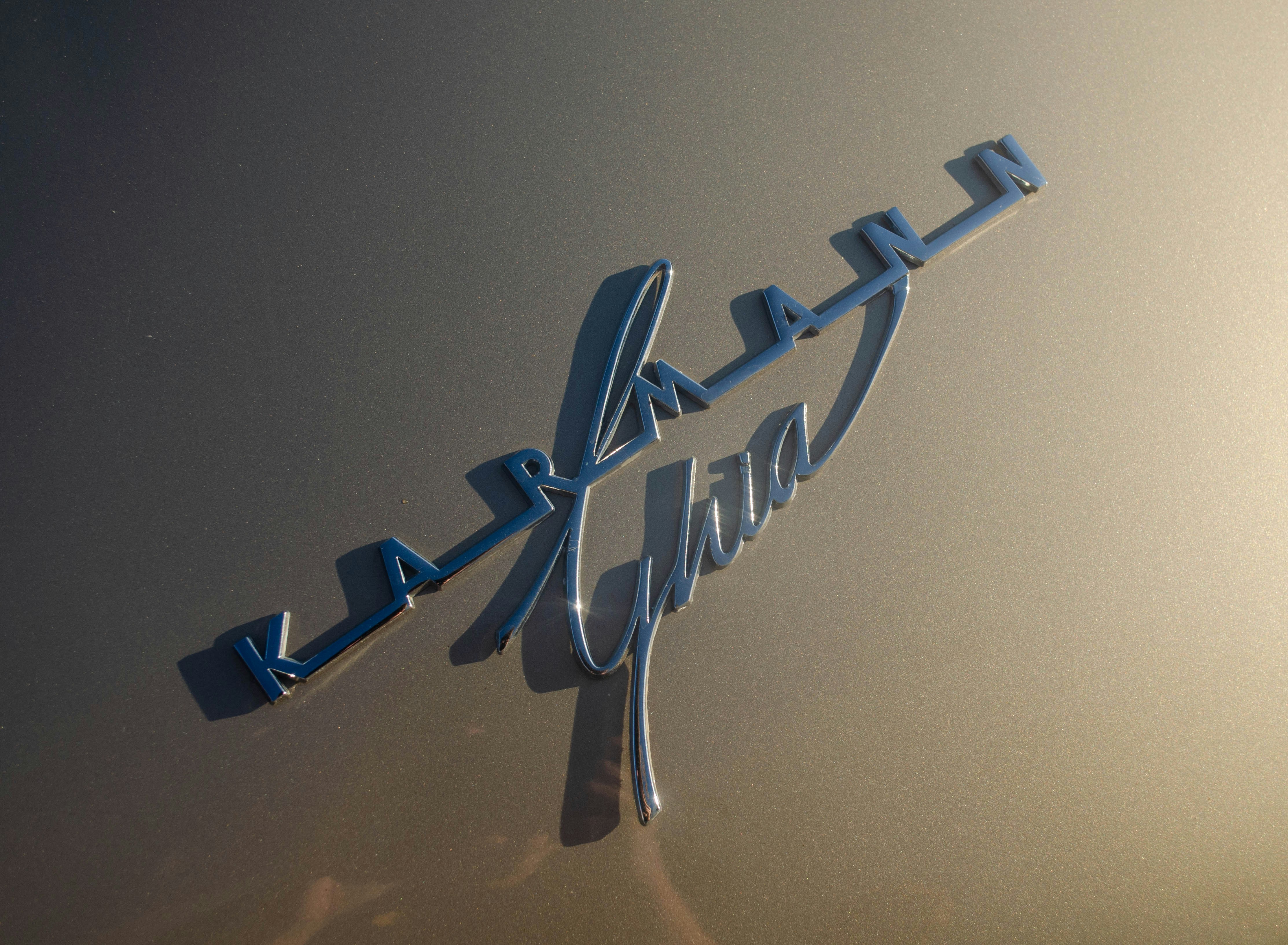 Hybrid Heritage: Classic Script Emblem on Metallic Surface