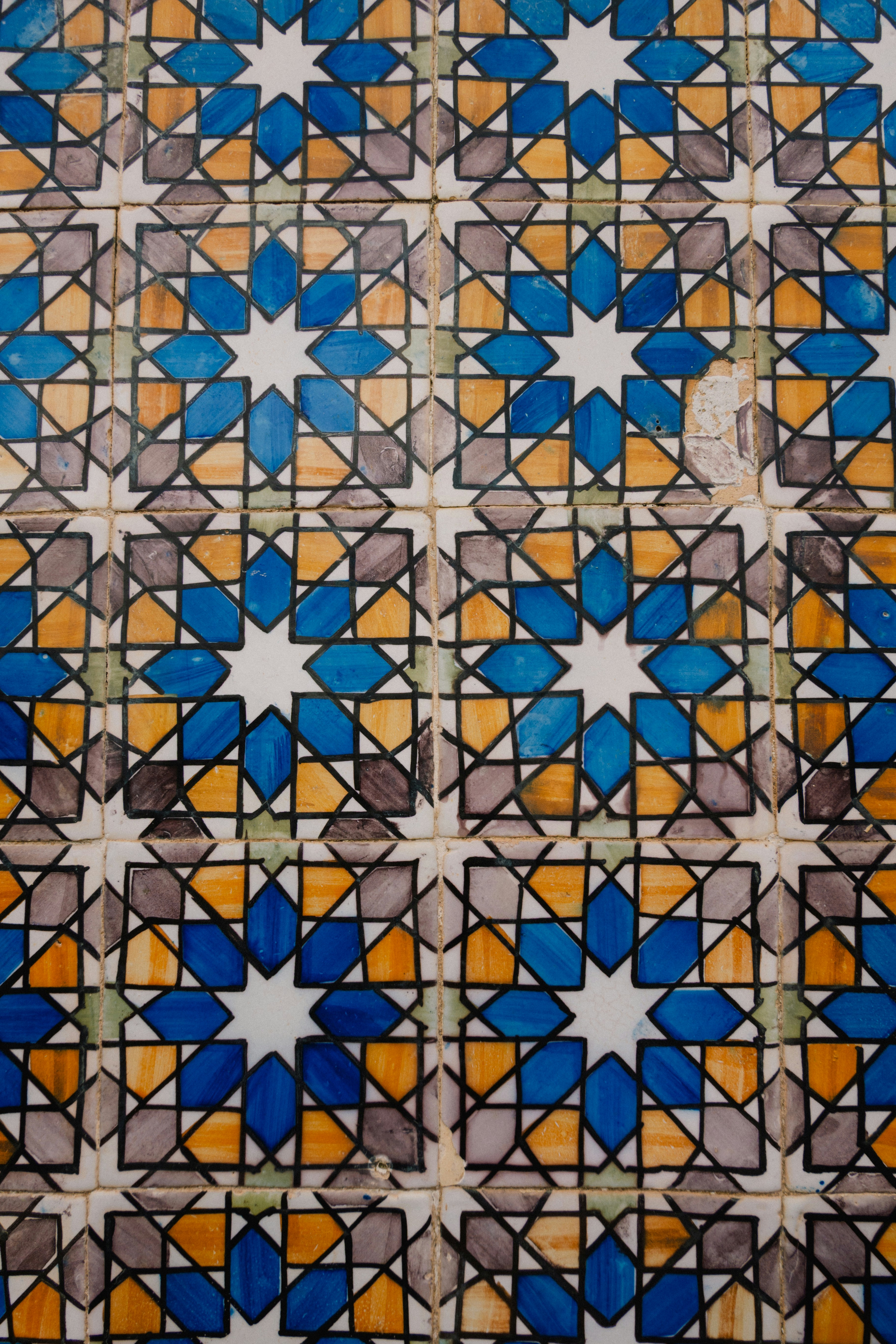 Geometric Mosaic: Repeating Blue Stars in Ceramic Tiles