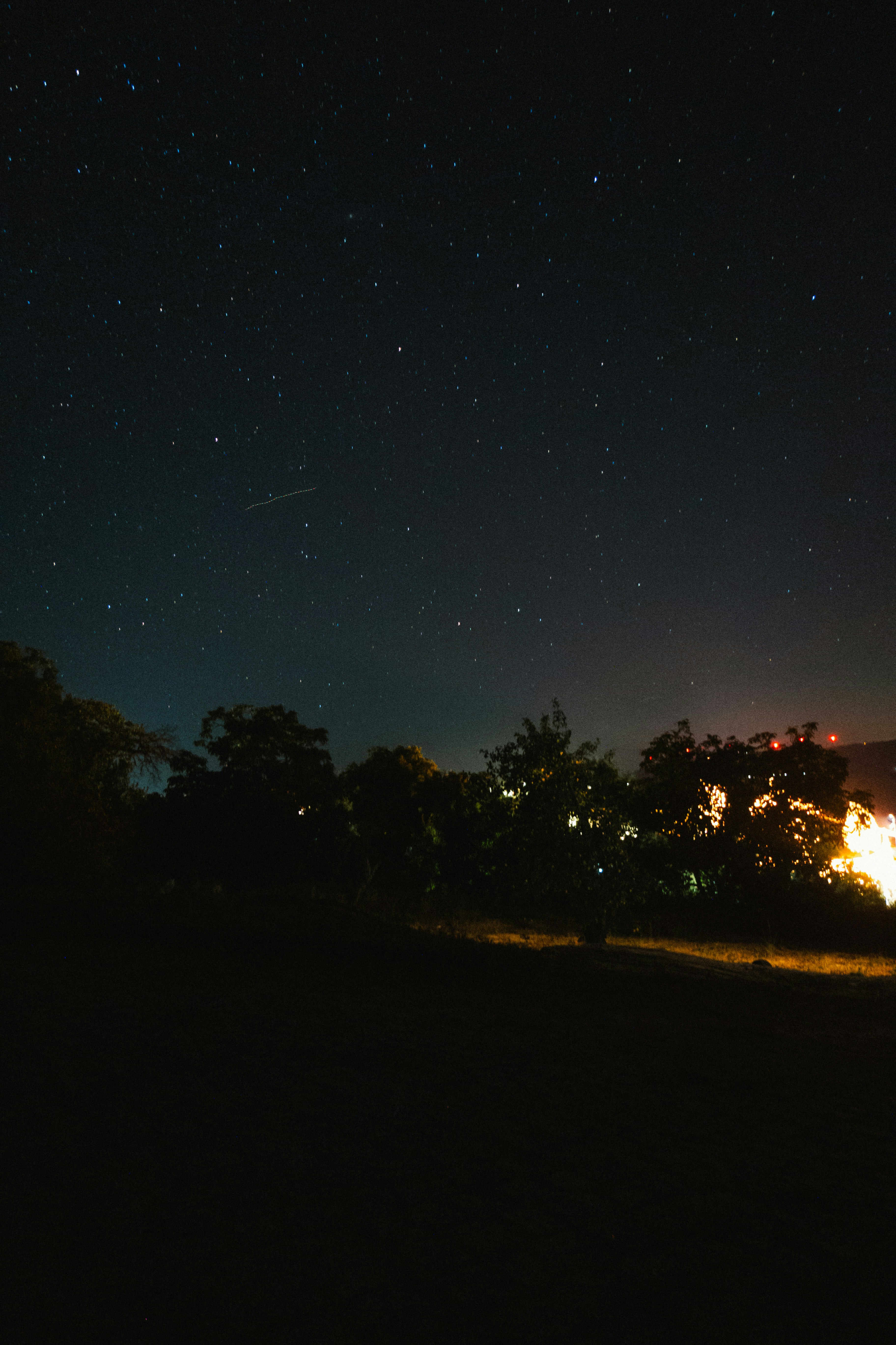 Night Sky Over a Quiet Horizon with Distant Lights