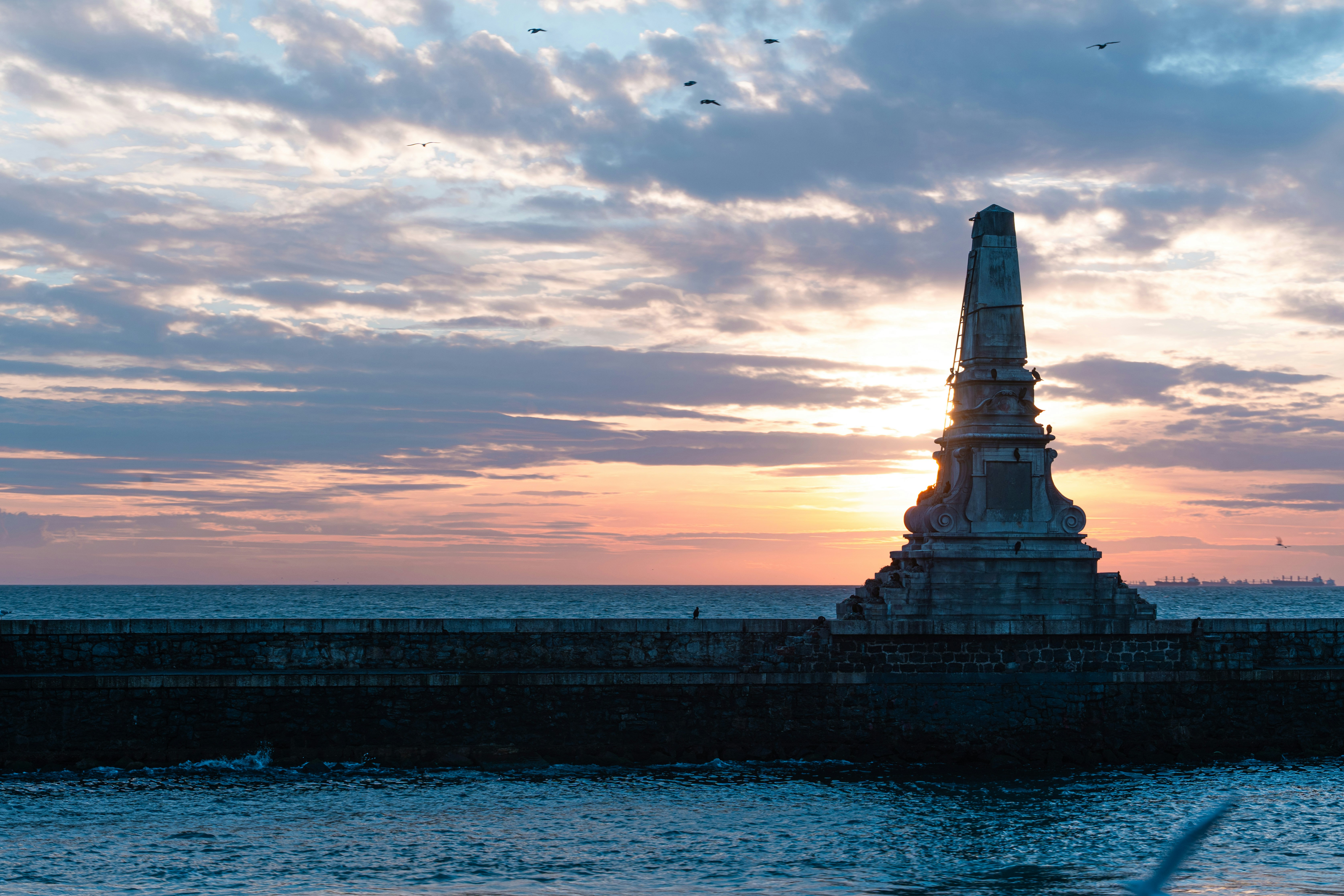 Sunrise over the Promenade: A Lighthouse Pier at Dusk