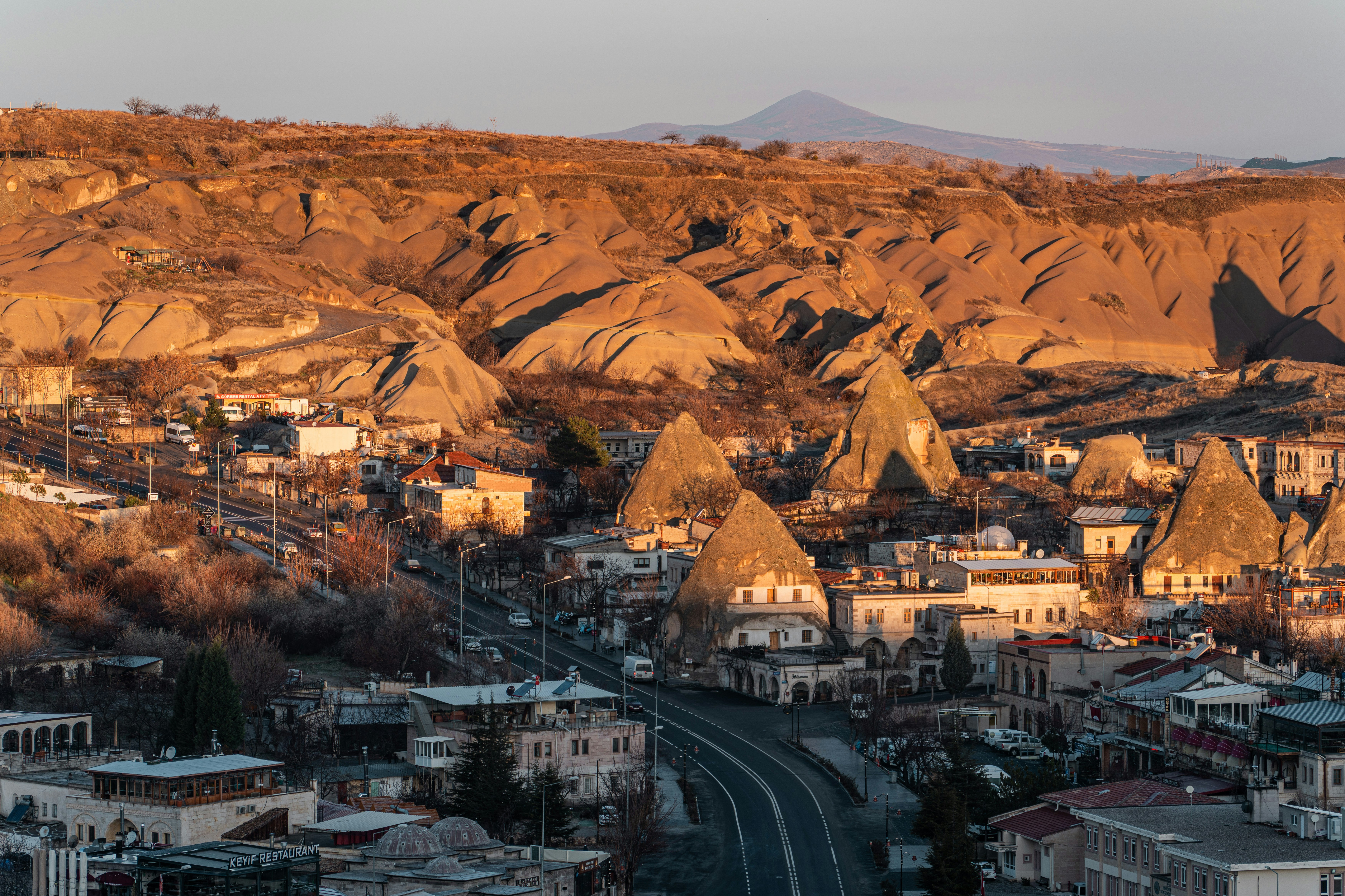 Sunlit Valleys and Conical Roofs: A Desert Town at Dusk