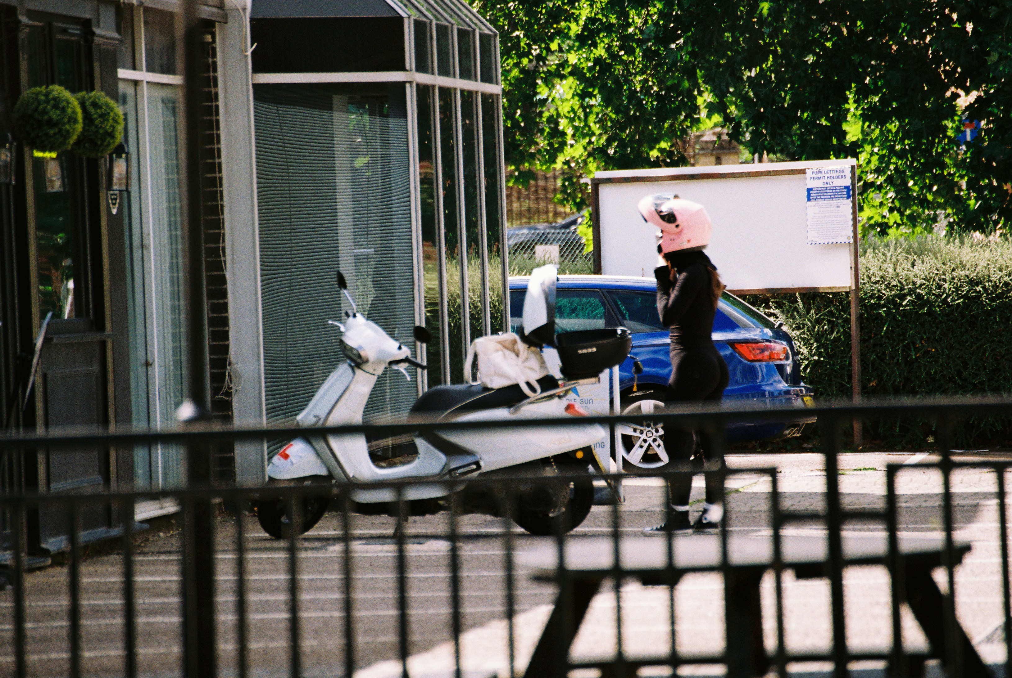 Scooter Stop: A Quiet Urban Moment with a Gloved Rider