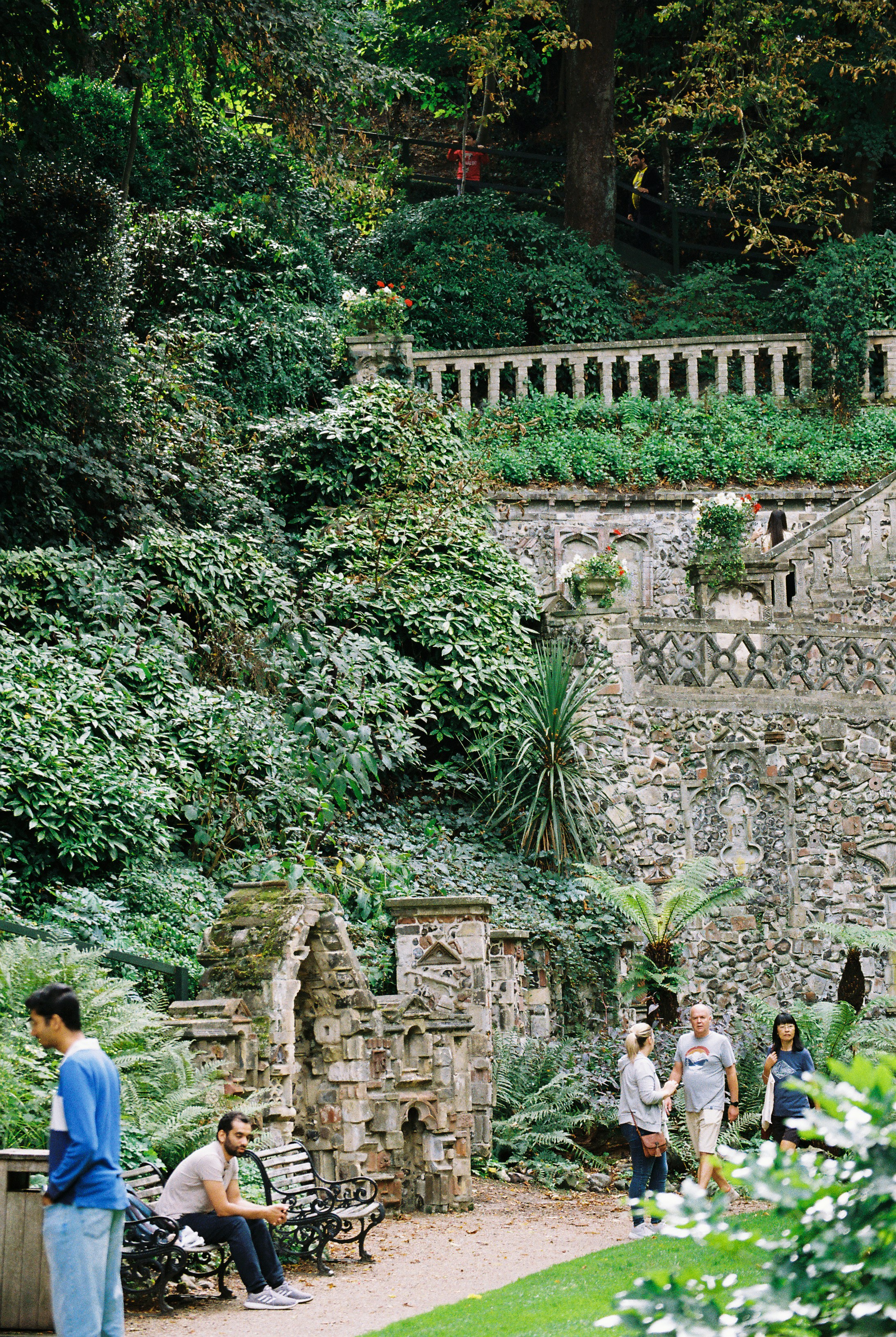 People among ancient terrace walls in a lush garden