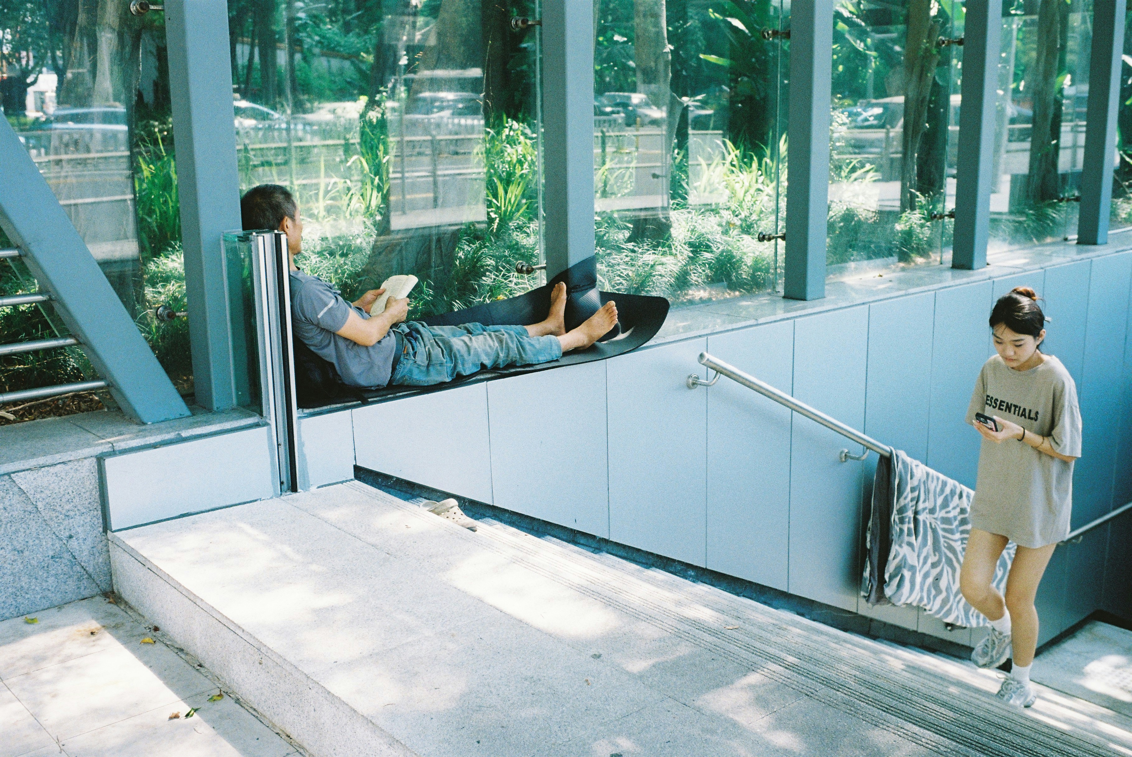 Two Quiet Moments in a Glass-wrapped Plaza