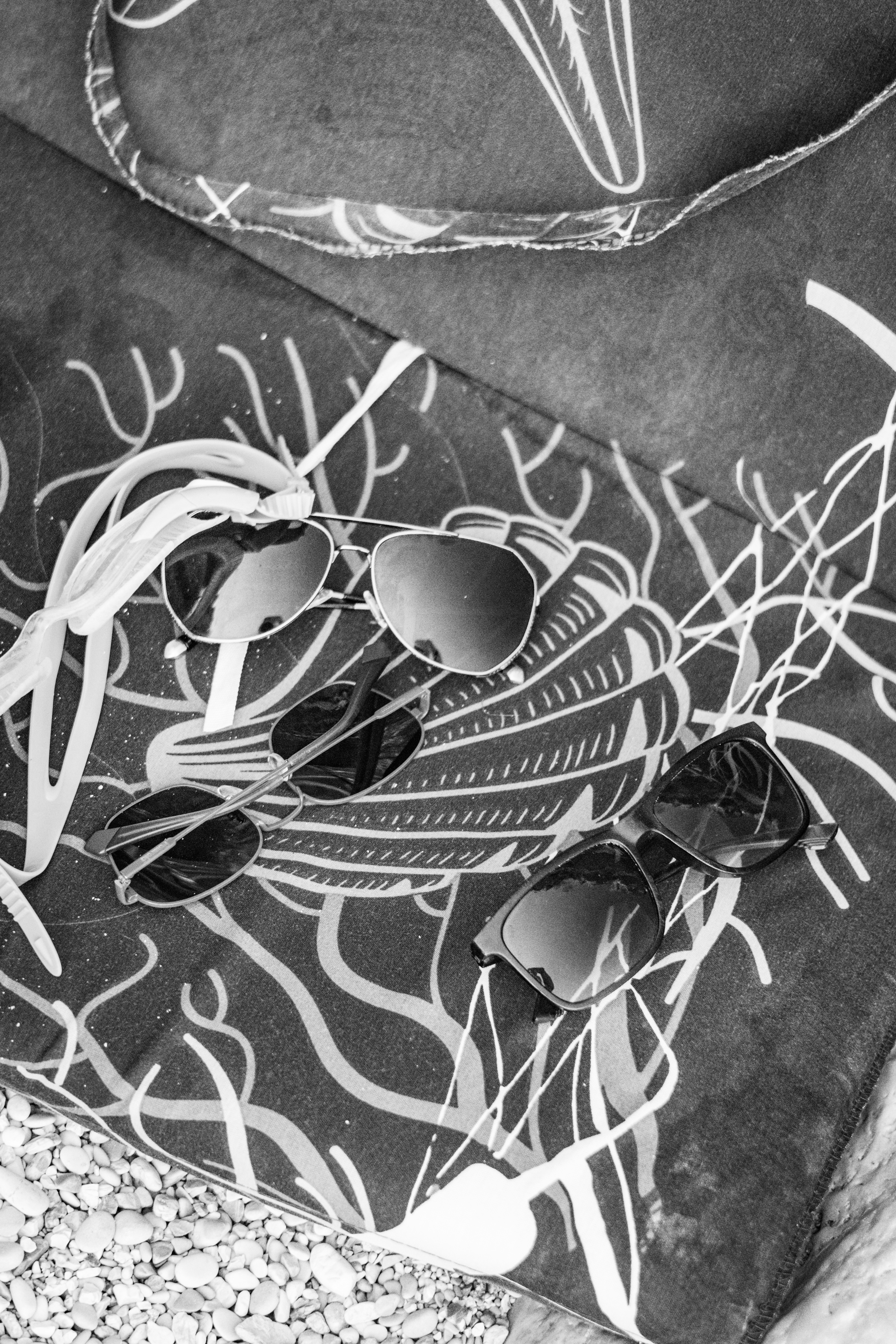 Scatter of Sunglasses on a Printed Fabric Surface