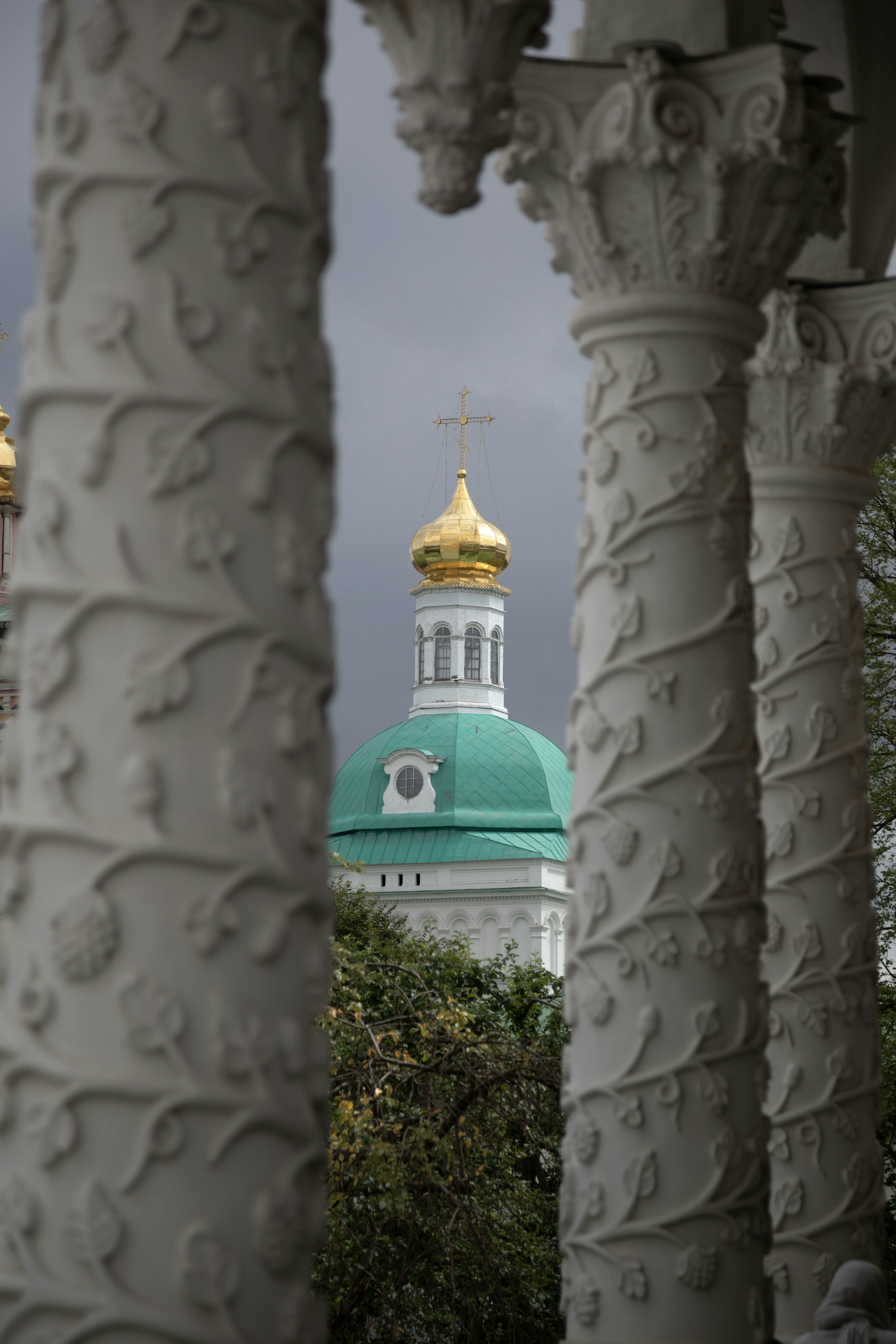 Green Dome, Golden Cross: A Pilgrim’s View through Ornate Columns