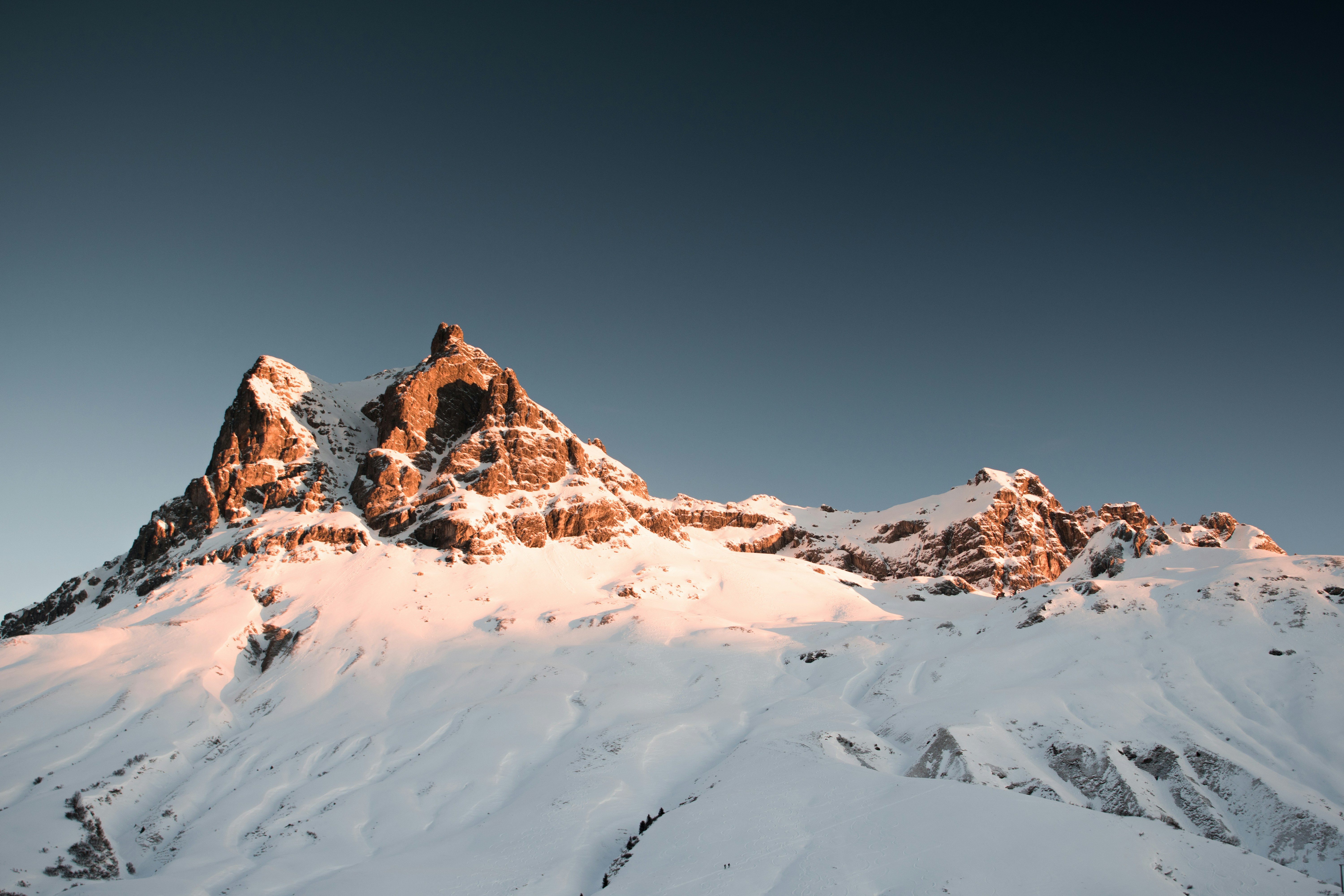 Sunlit Summit: A Crystalline Peak Emerges from the Snow