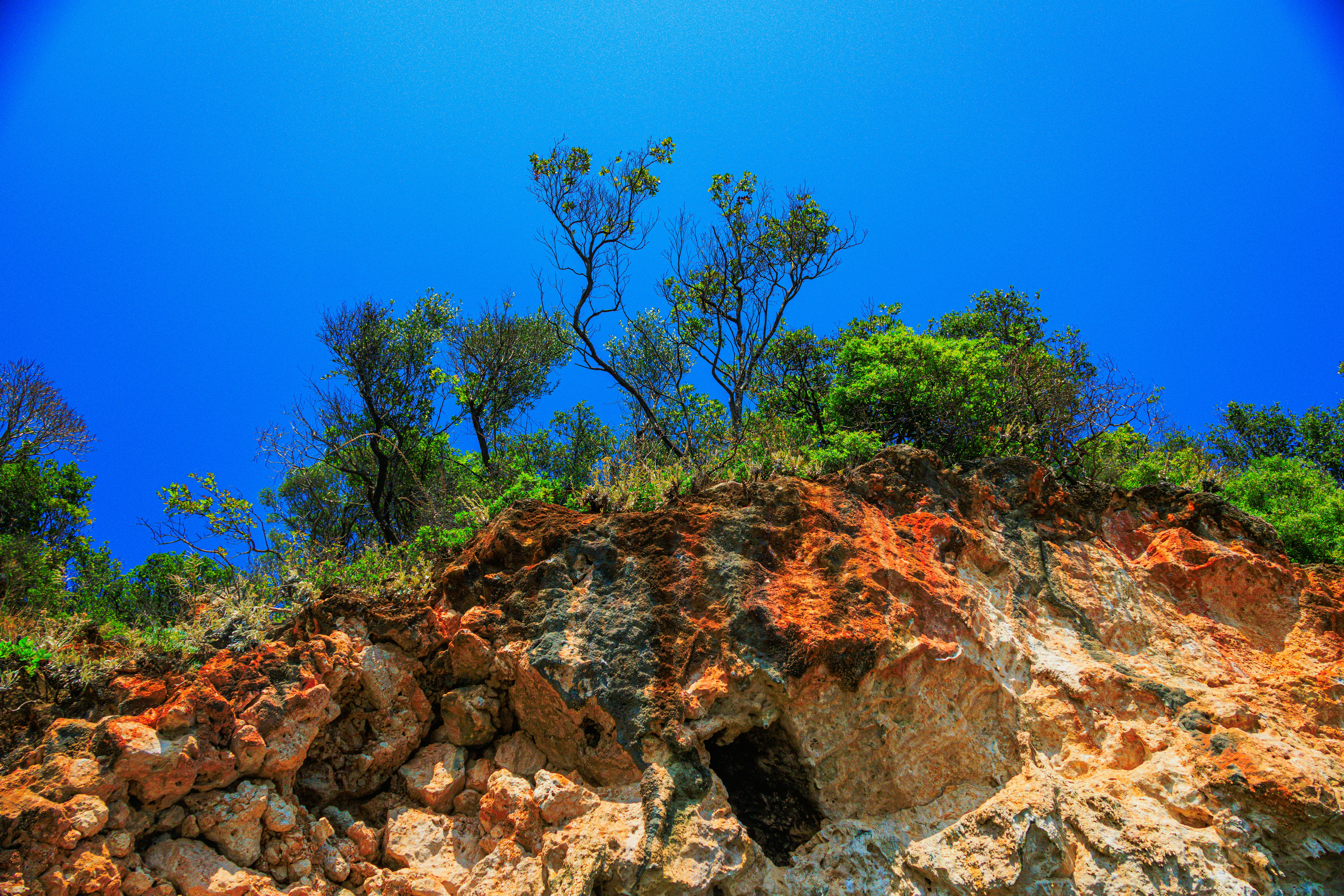Cliffside Chronicle: A Quiet Verge of Blue Sky and Rusted Stone