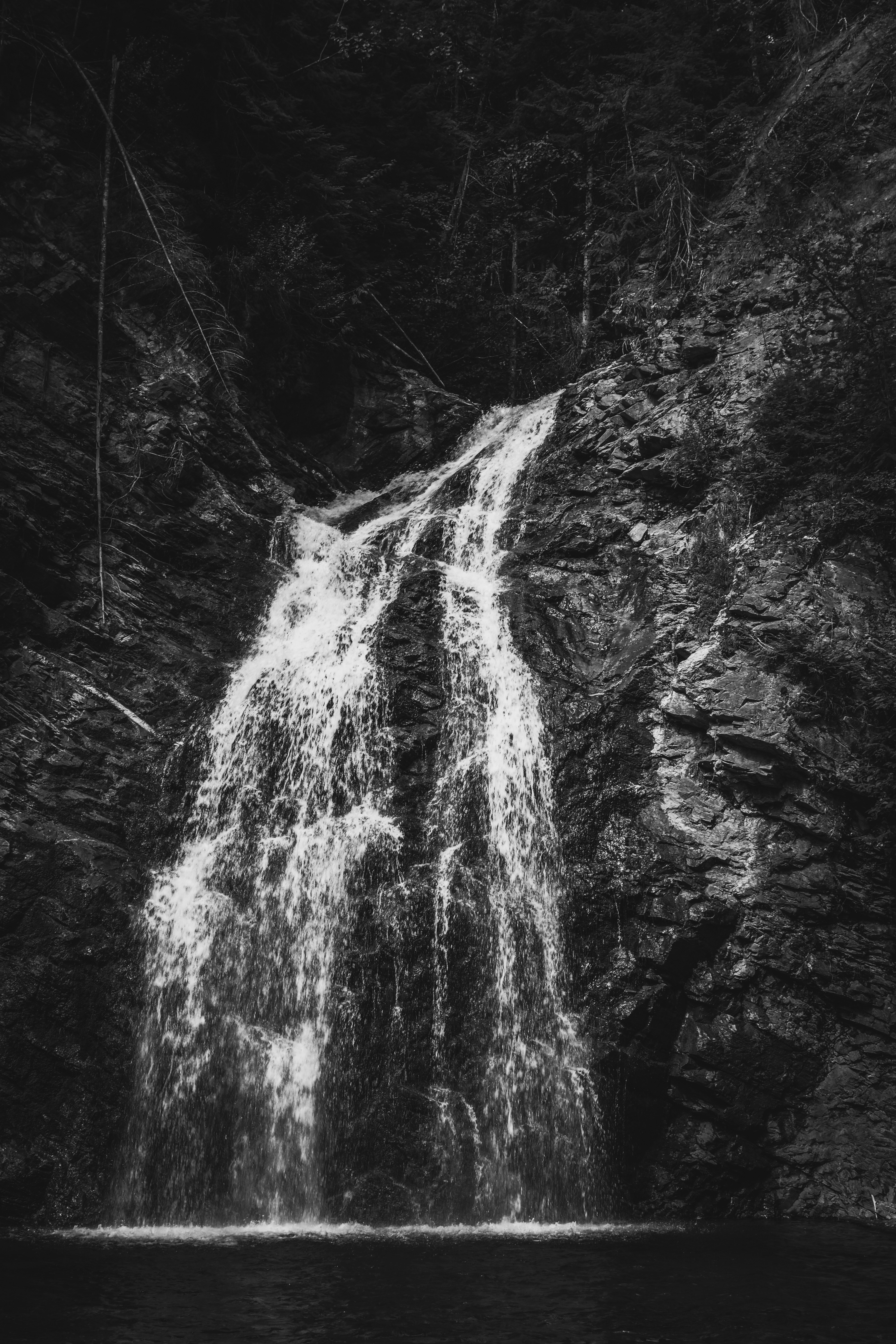 Monochrome Cascade: A Midnight Waterfall against rugged cliff