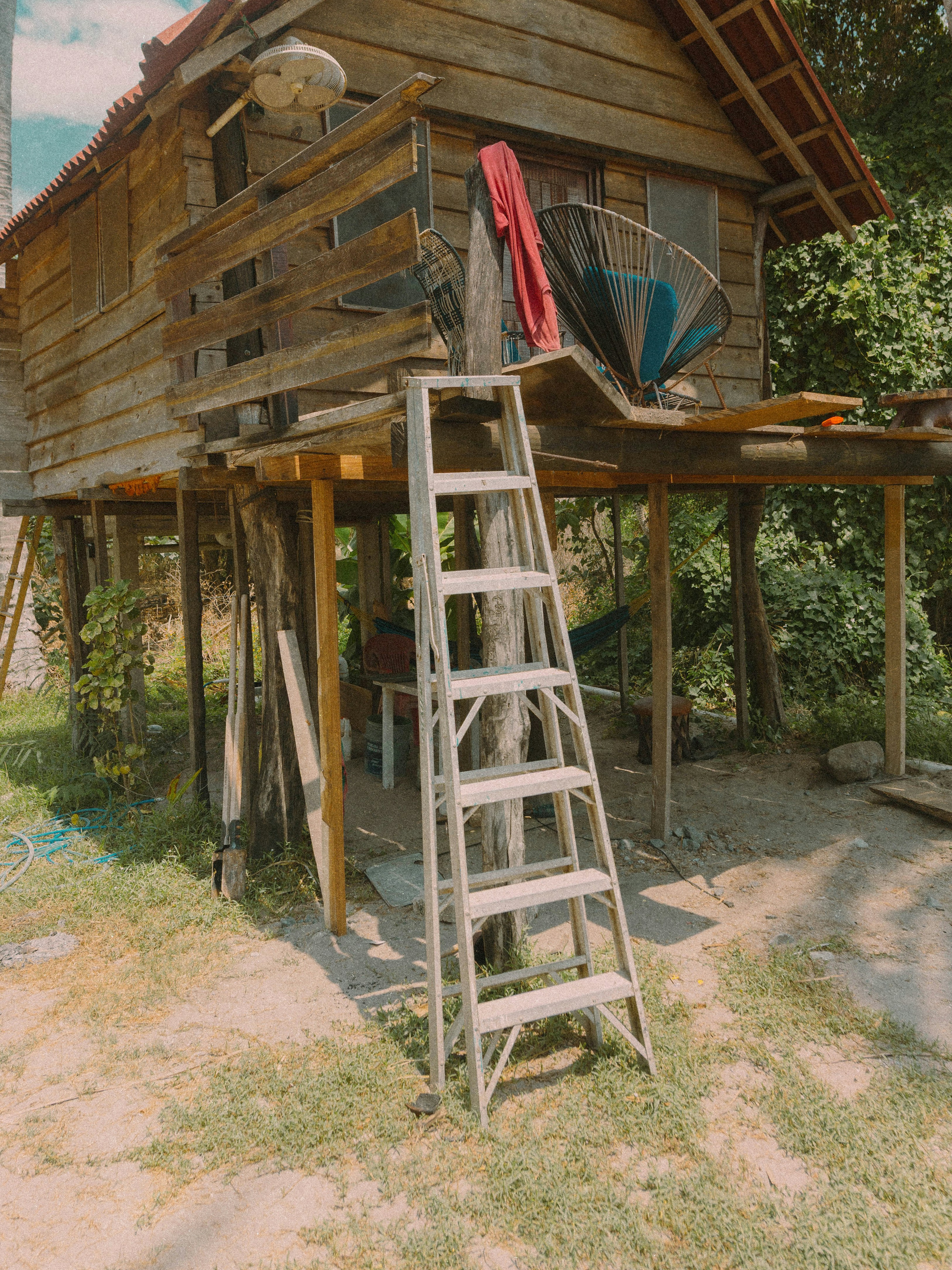 Tree-House Workbench: Ladder Propped Under a Rustic Loft