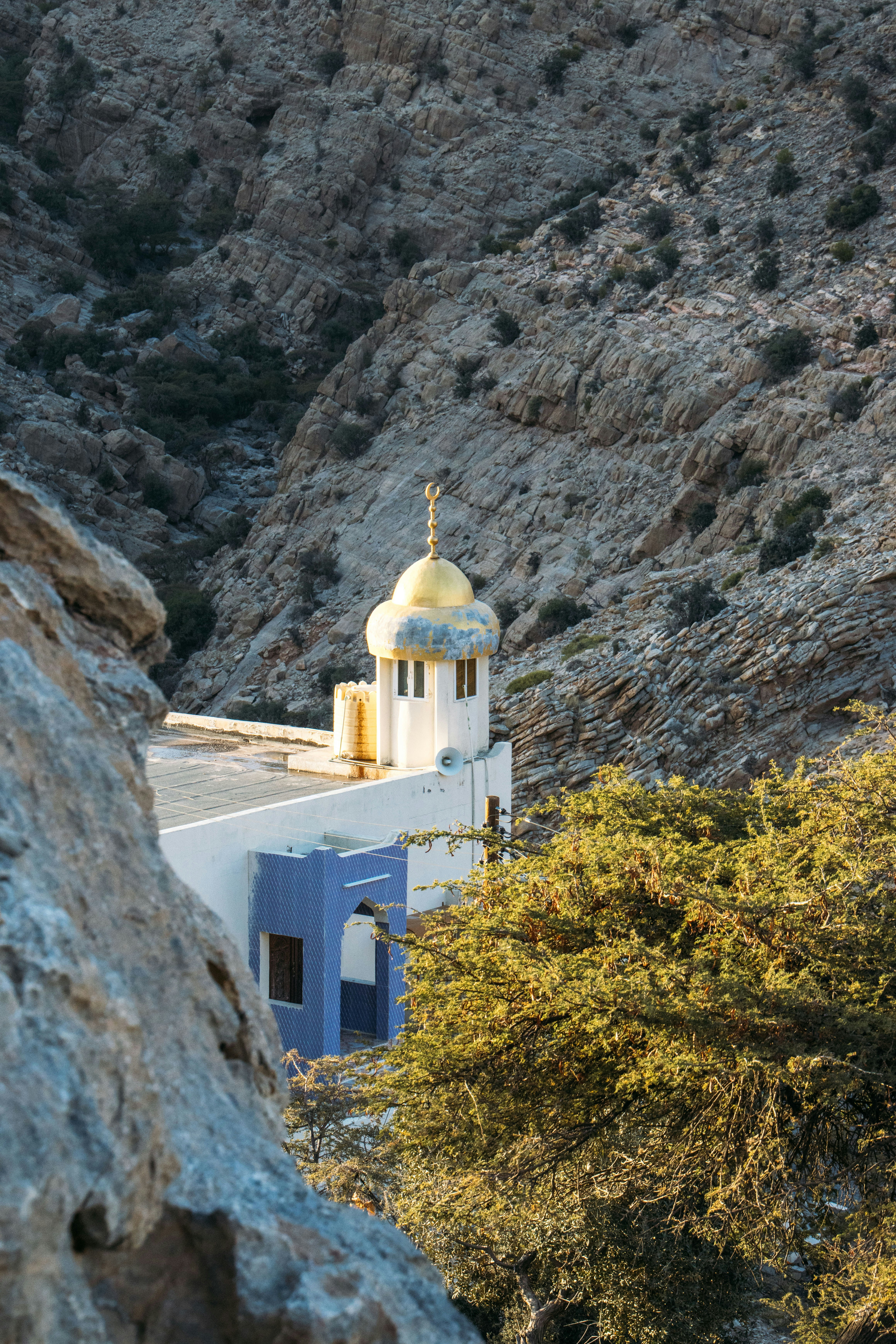 White chapel crown amid rugged cliffs