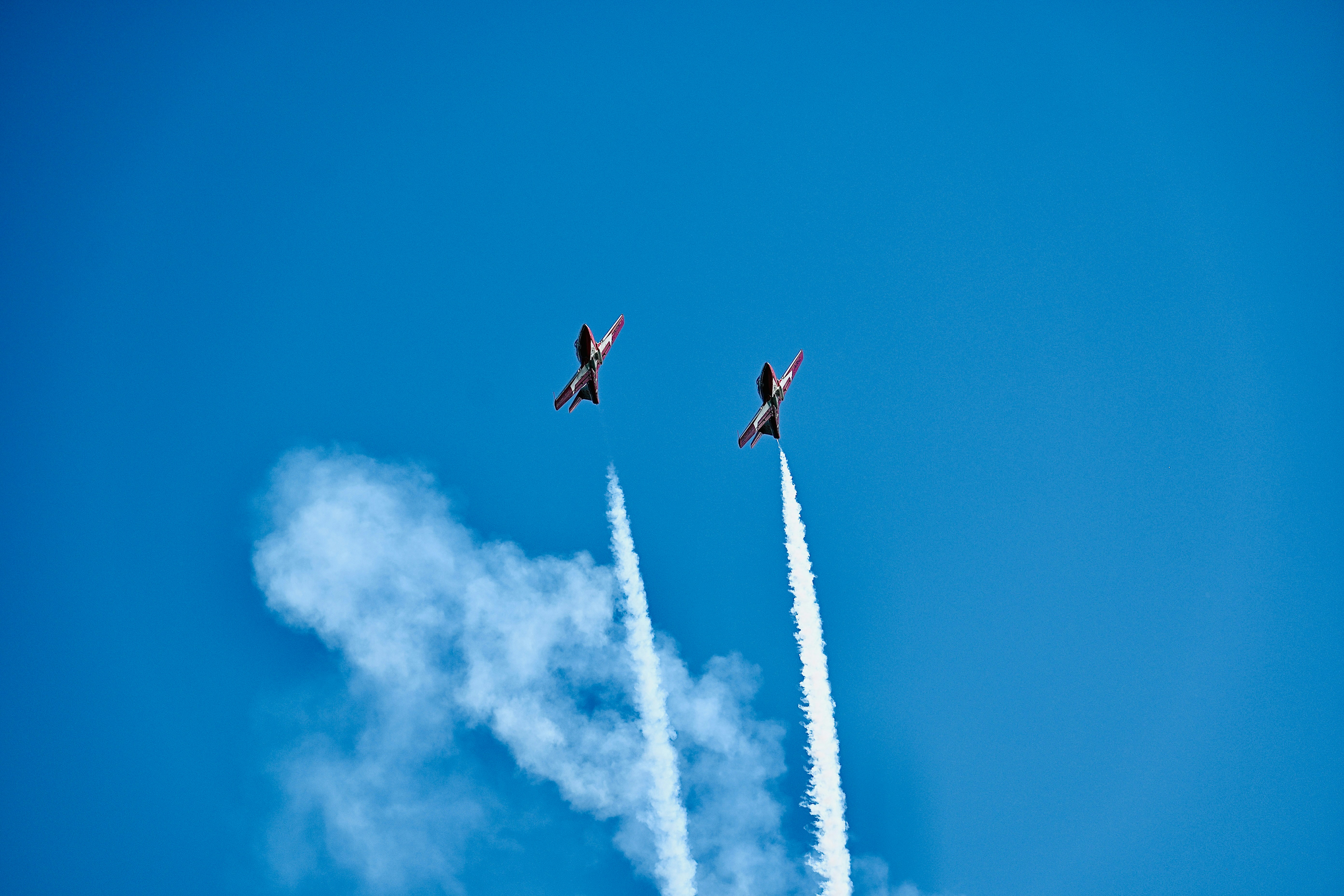 Twin Contrails: Aircraft Acrobatics Piercing a Clear Blue Sky