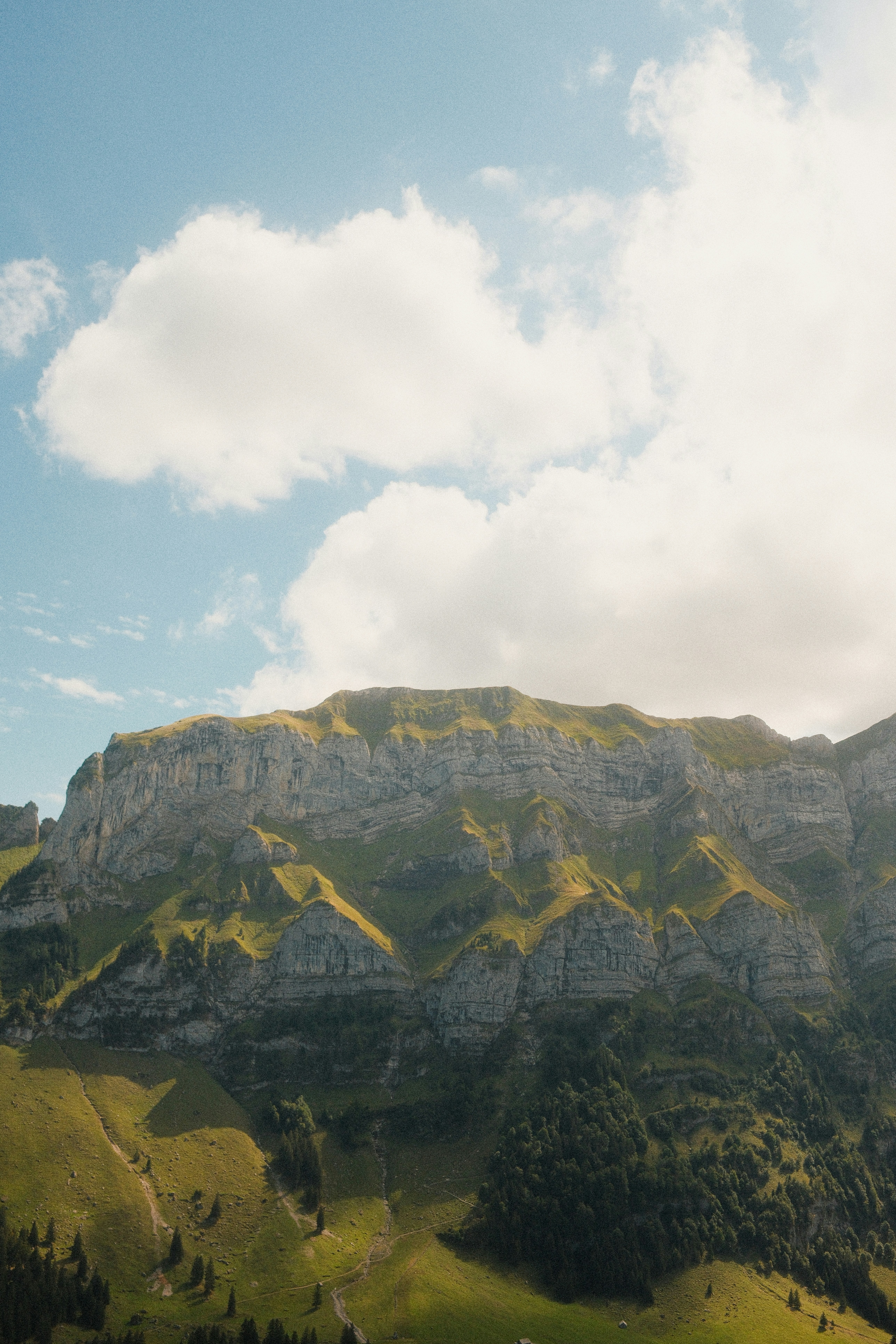 Sunlit Ridge: Alpine Cliffs Beneath a Sawtooth Sky
