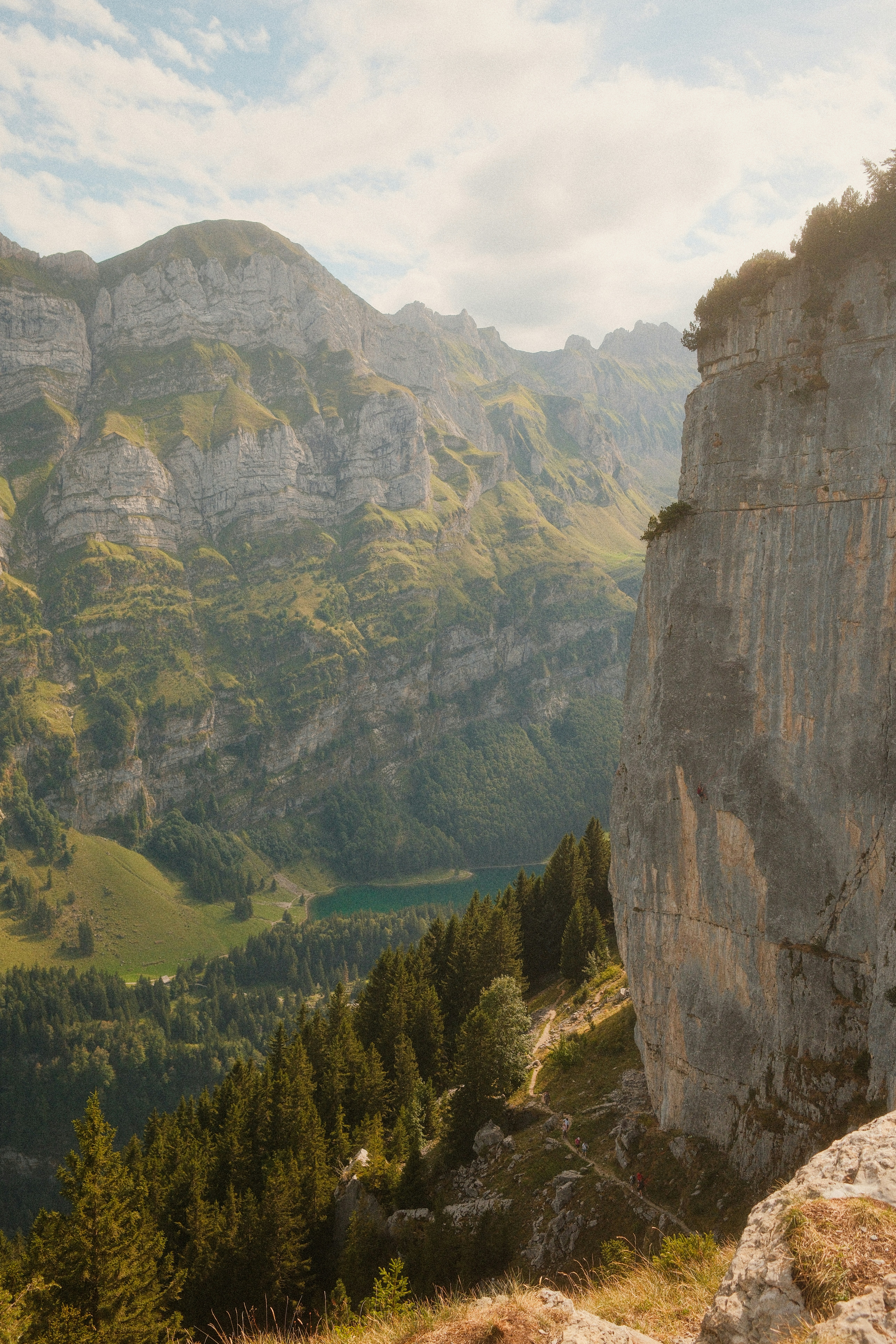 Vertical Cliff Against a Dawn-Valley Panorama