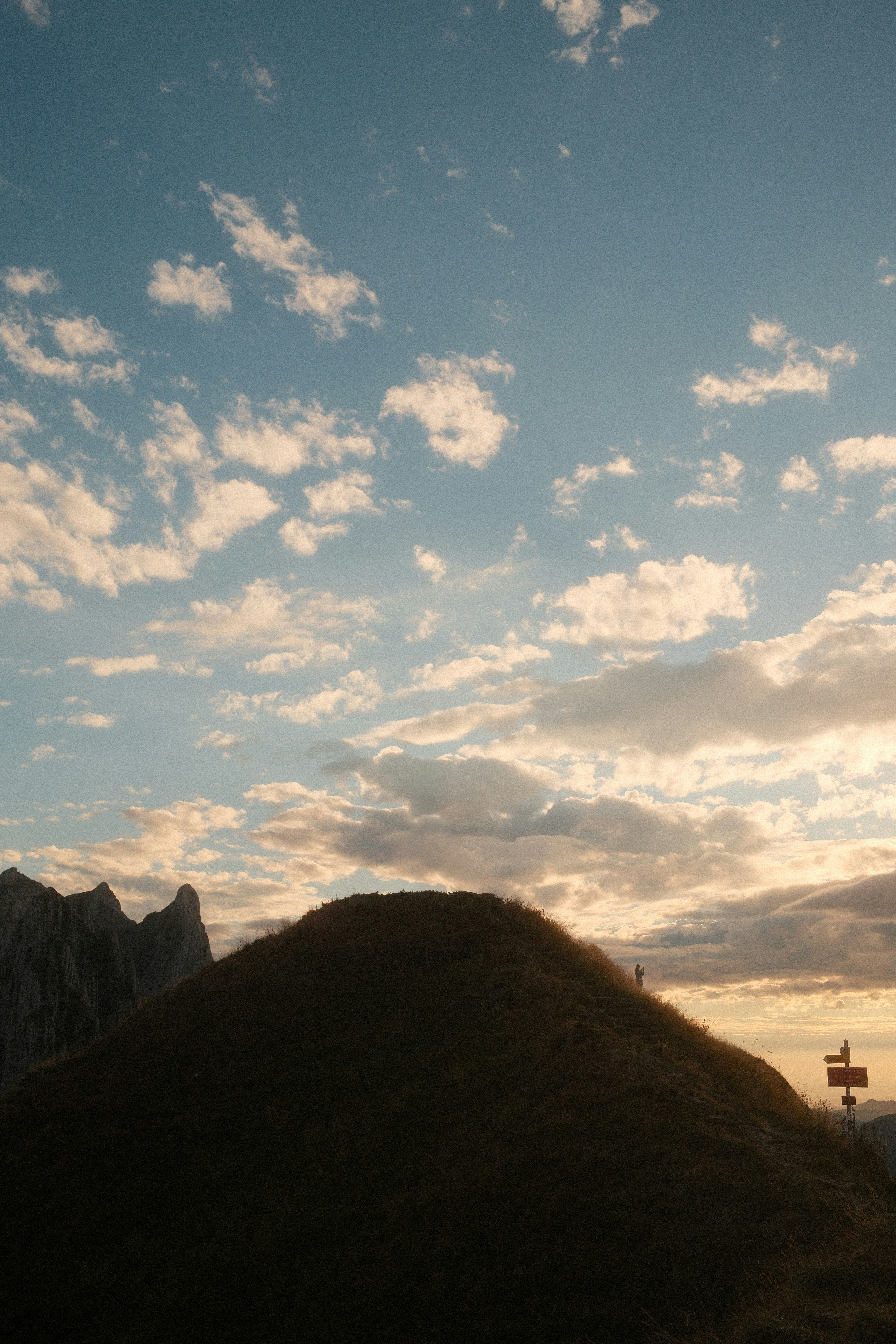 Dusk on the Hill: A Quiet Silhouette Against a Sky-full of Clouds