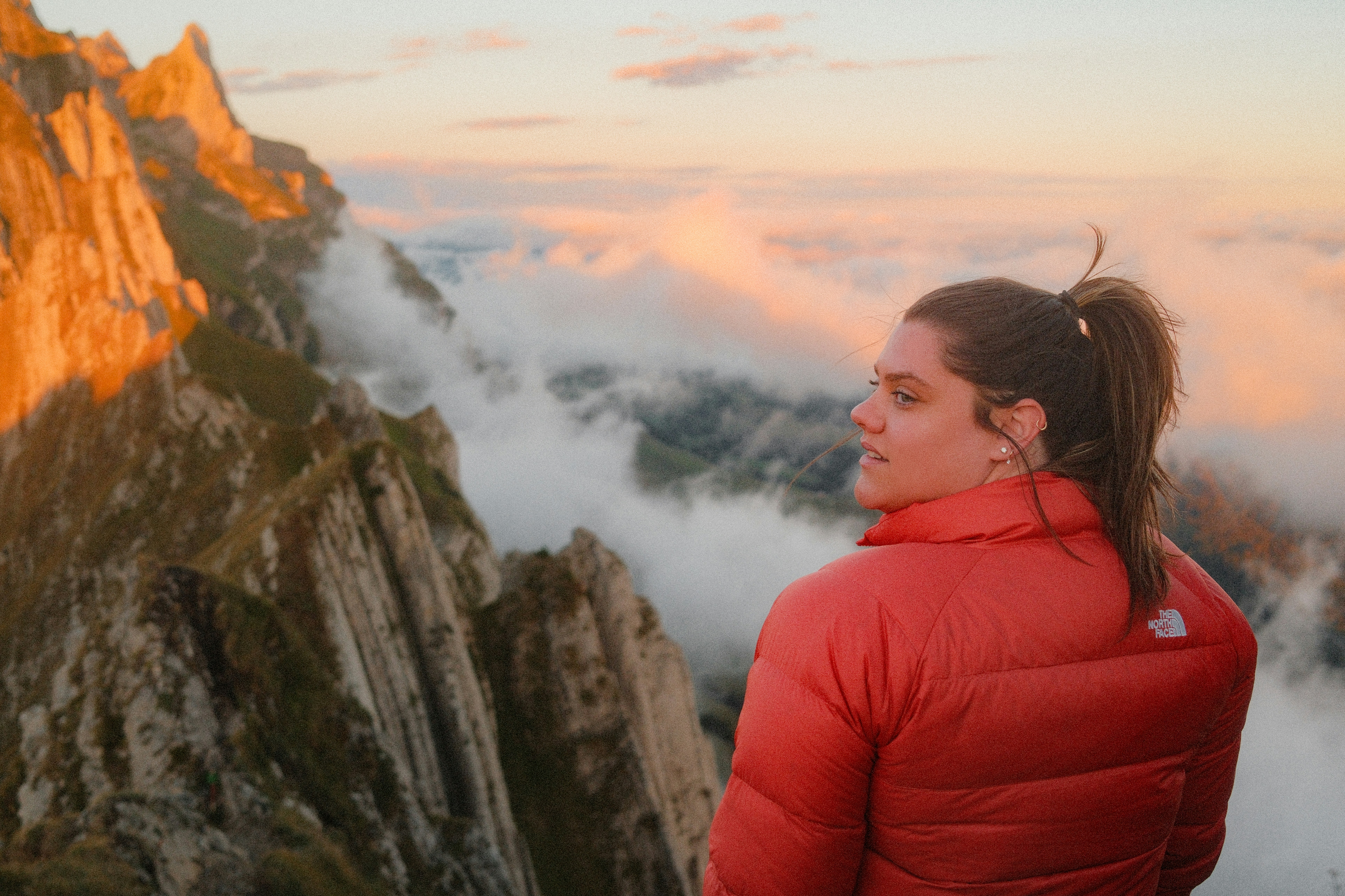 Mt. Helios Pact: A climber's quiet gaze against dawn clouds