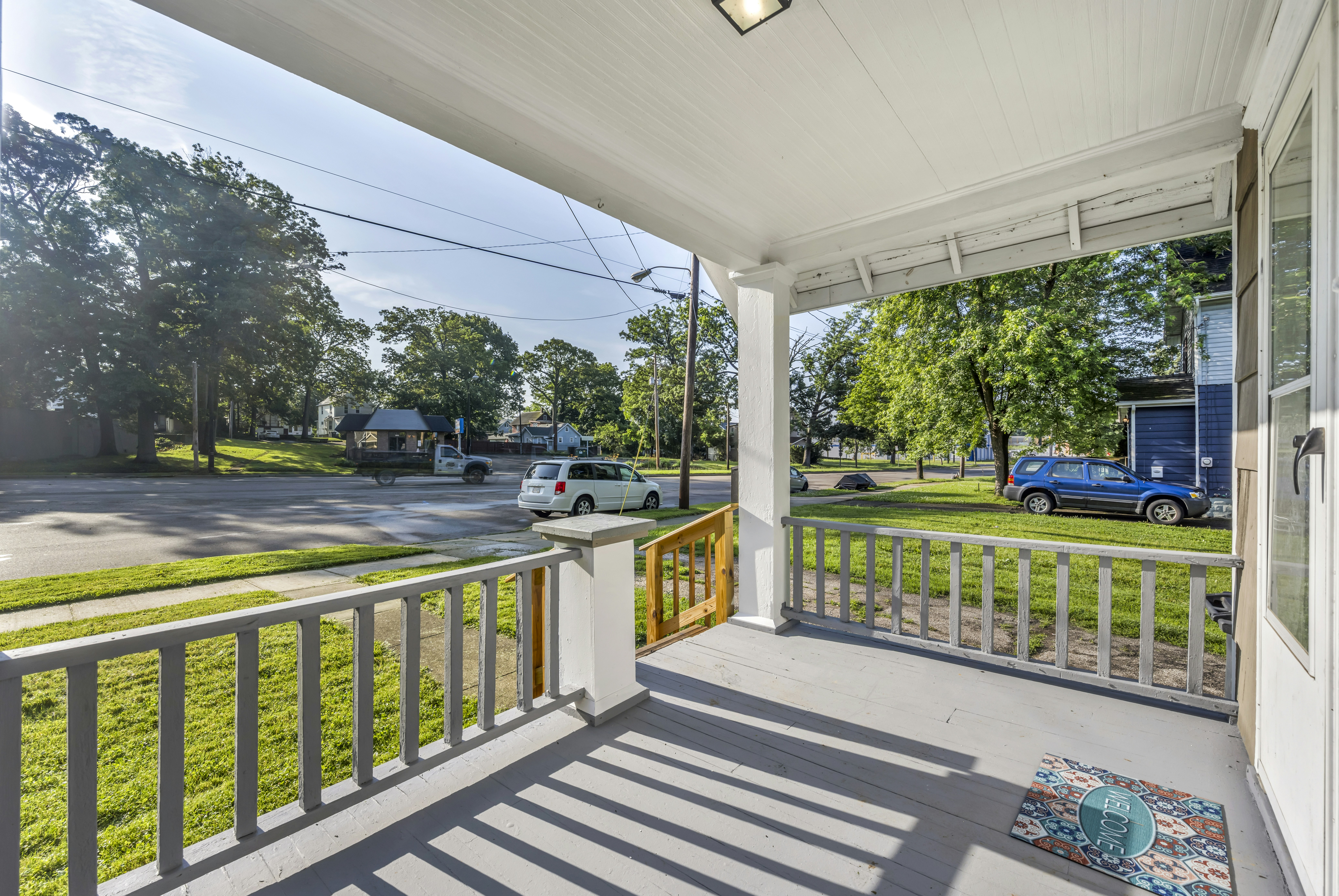 Sunlit Front Porch of a Quiet Suburban Lane