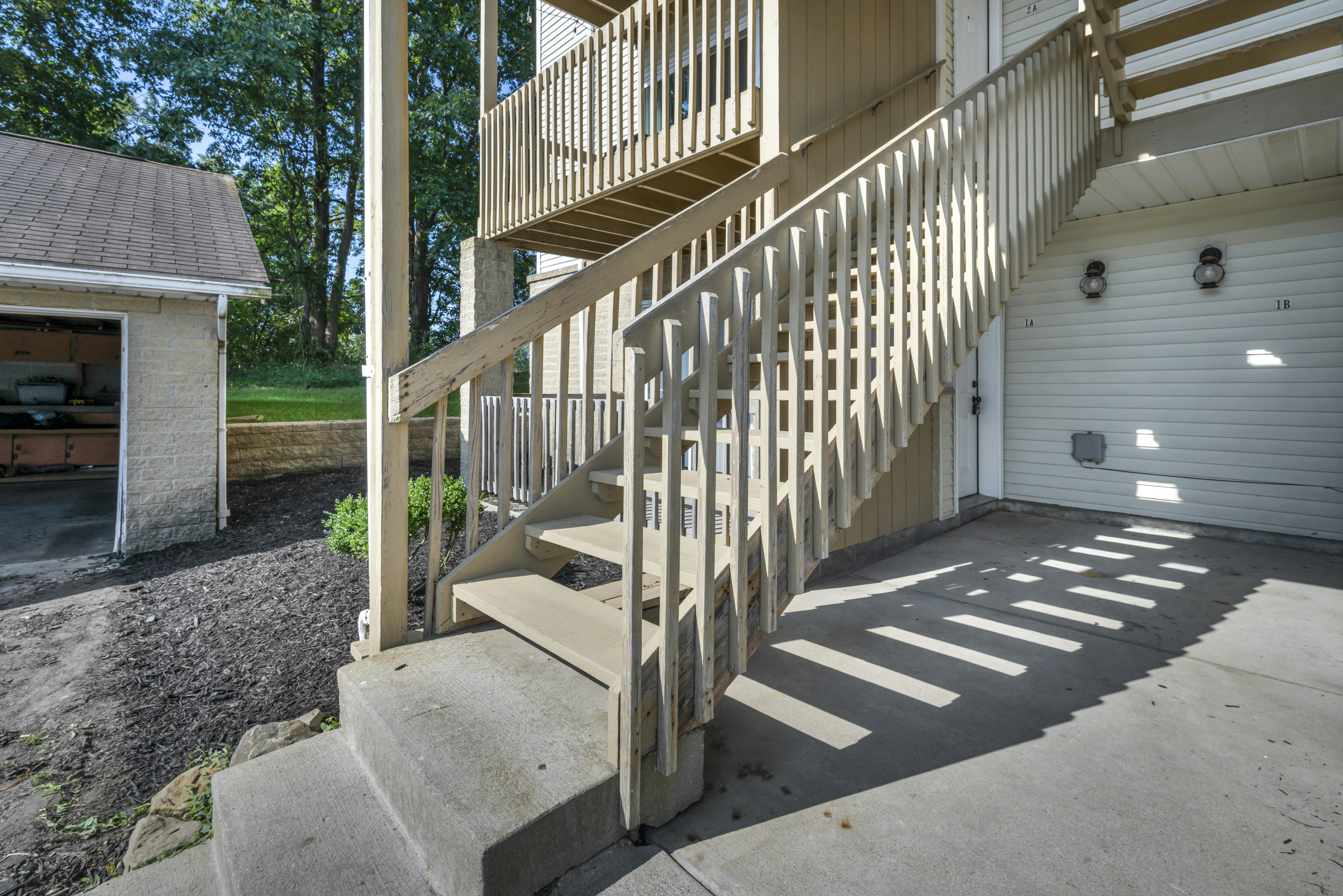 Staircase Shadows: A Concrete Path Between Deck and Garage