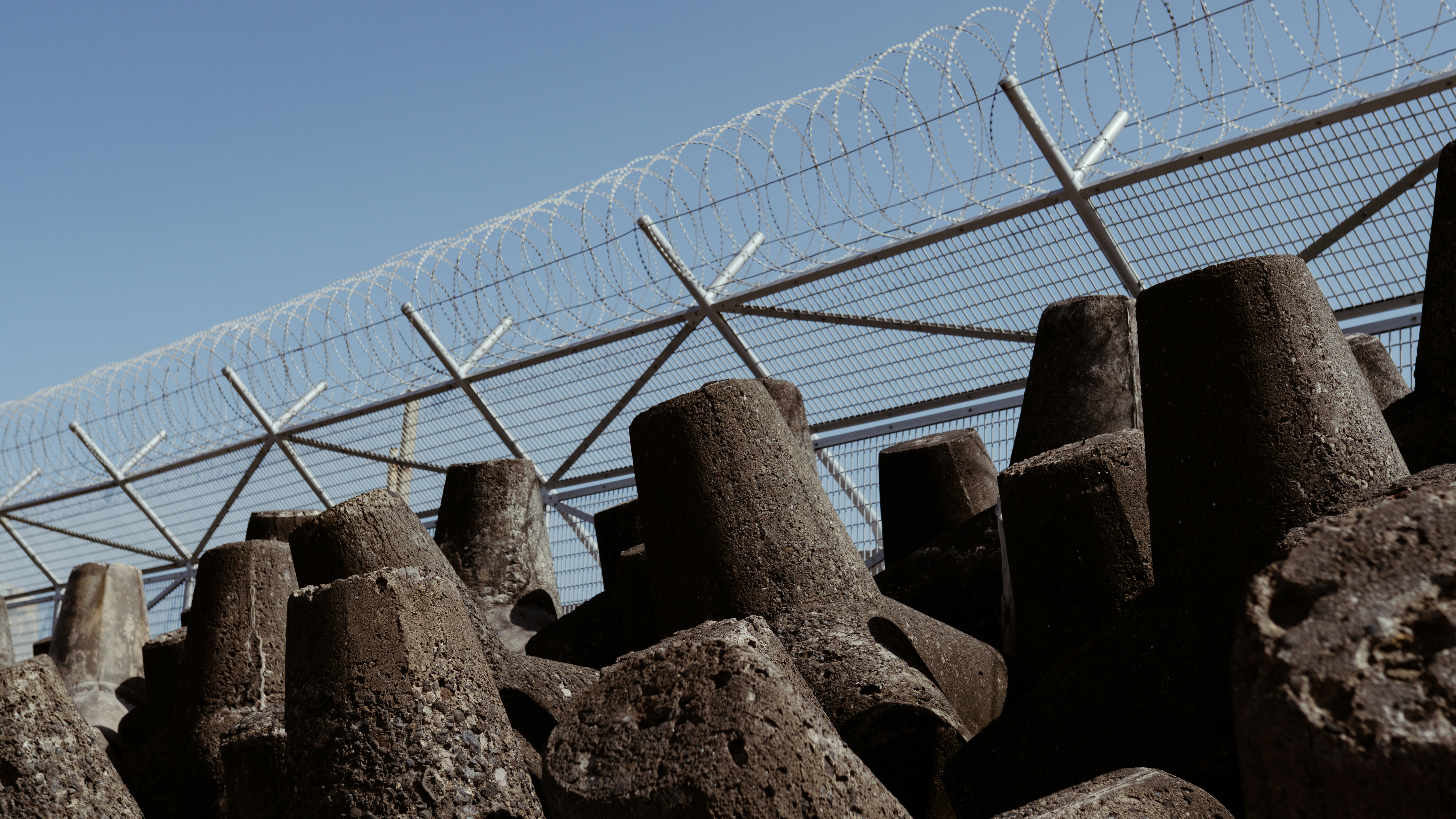 Barriers and Concrete Formations Under a Razor-Wire Sky