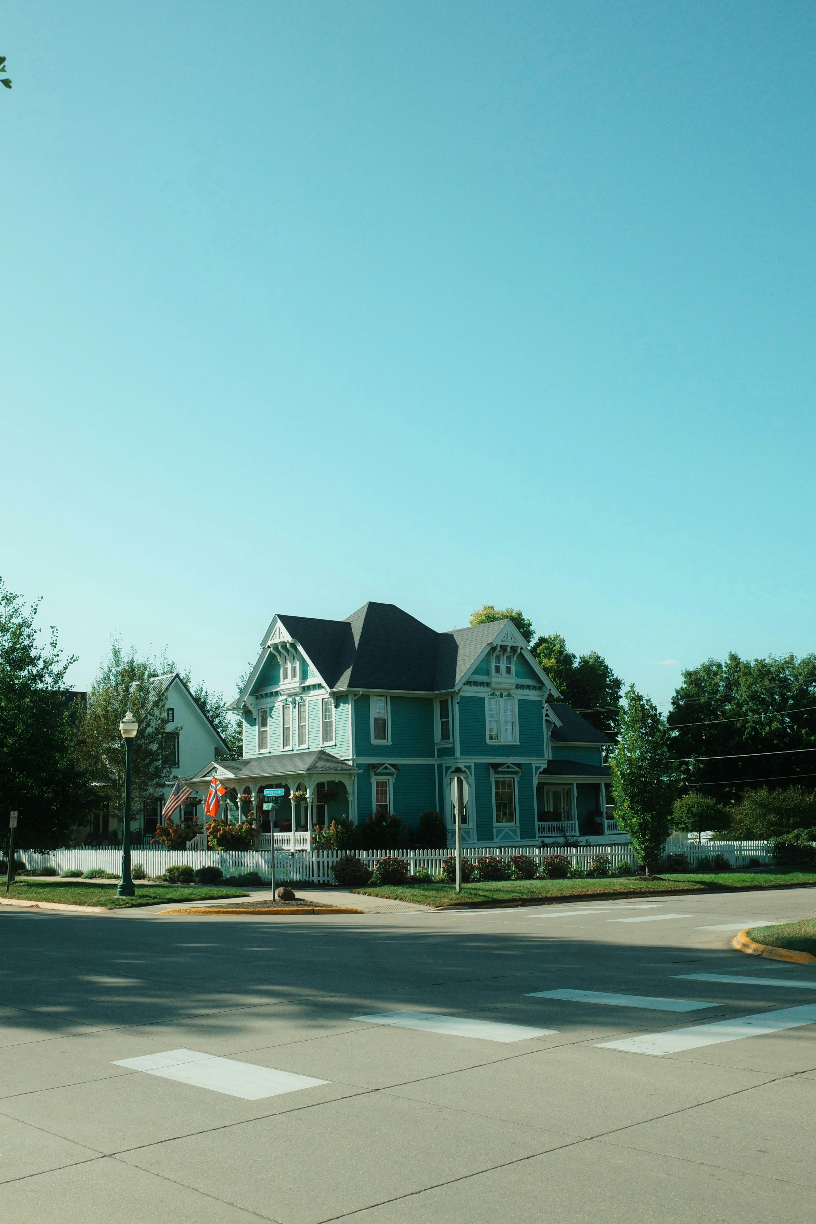 Pastel House on a Quiet Street Under a Clear Sky