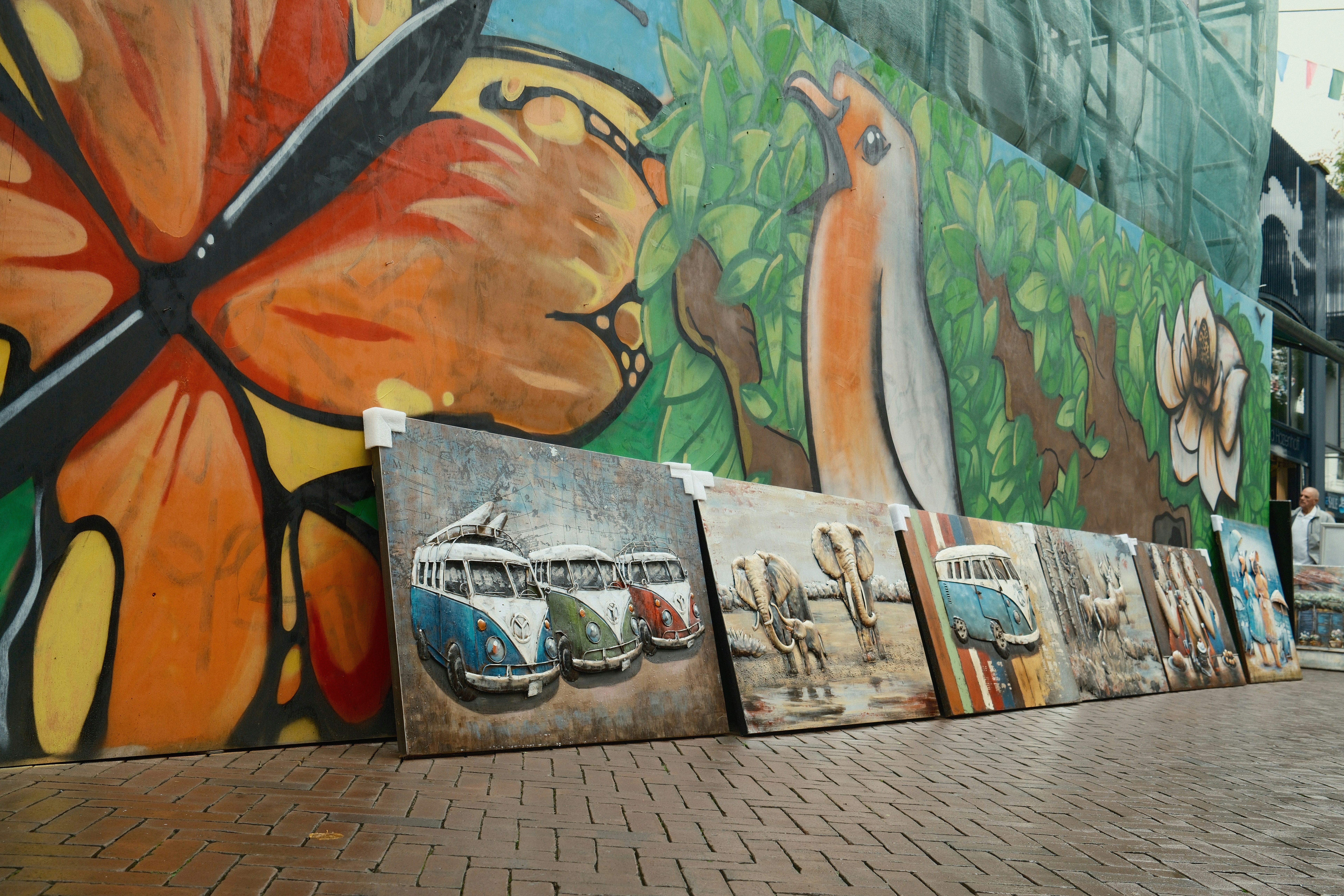 Street Gallery: A Row of Weathered Panels Before a Vivid Mural