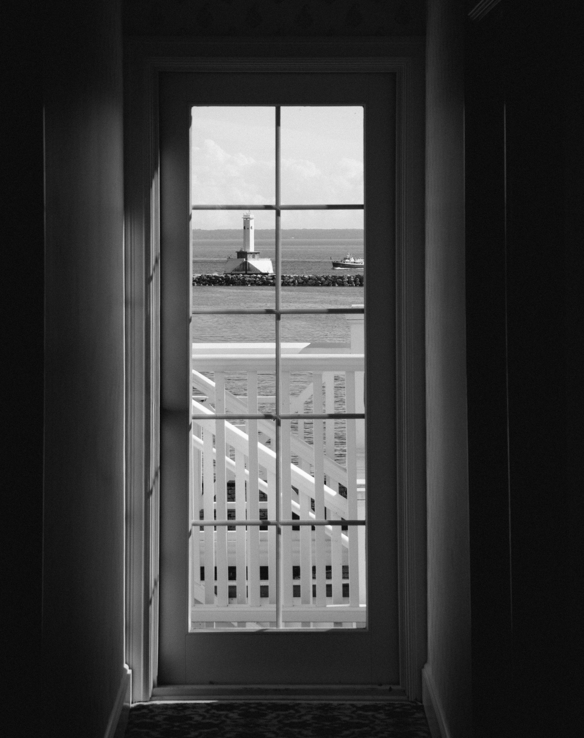 Through the Narrow Door: A Pier, Sea, and Lighthouse at Dawn