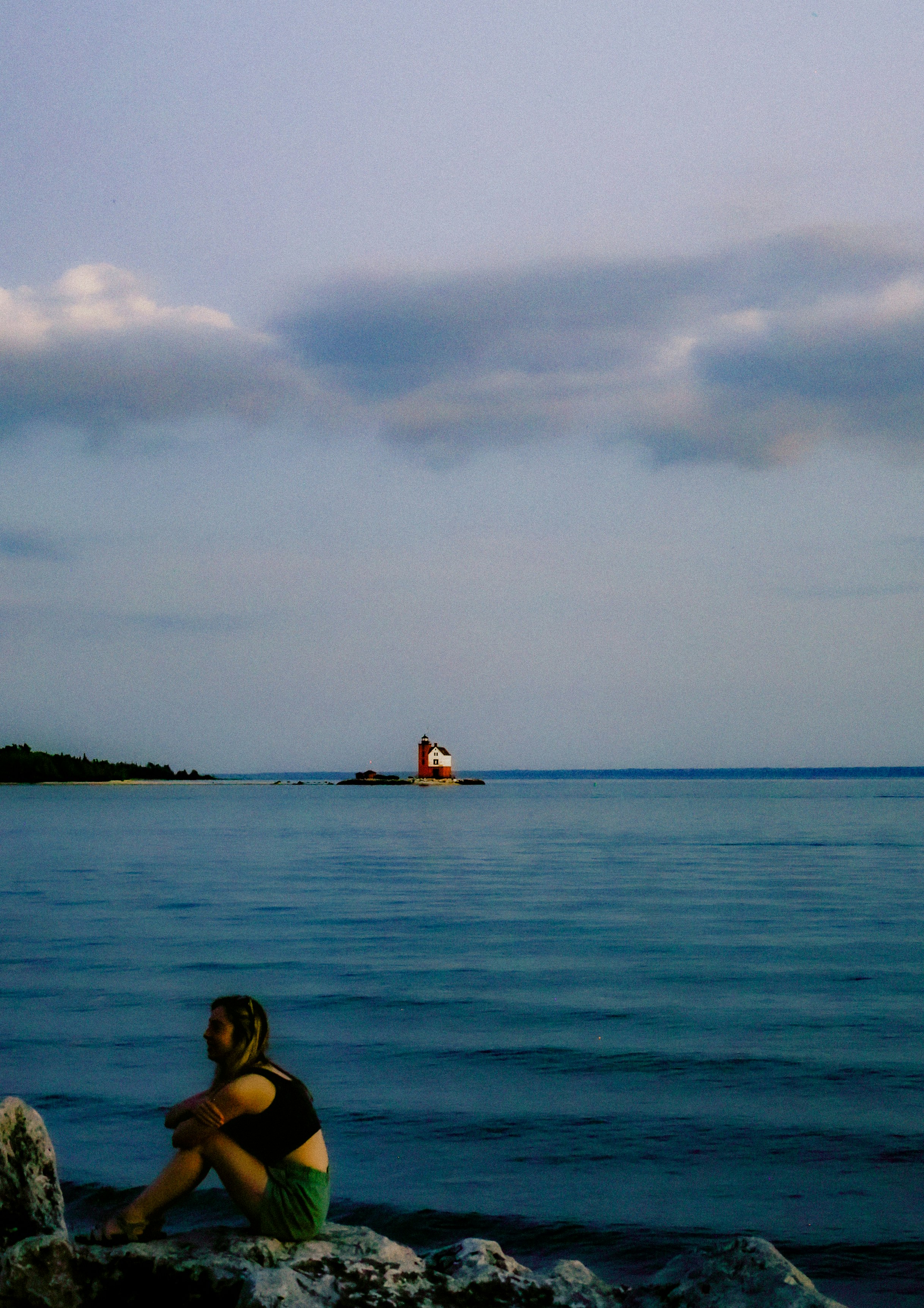 Lone Seaside Figure Beneath A Quiet Horizon