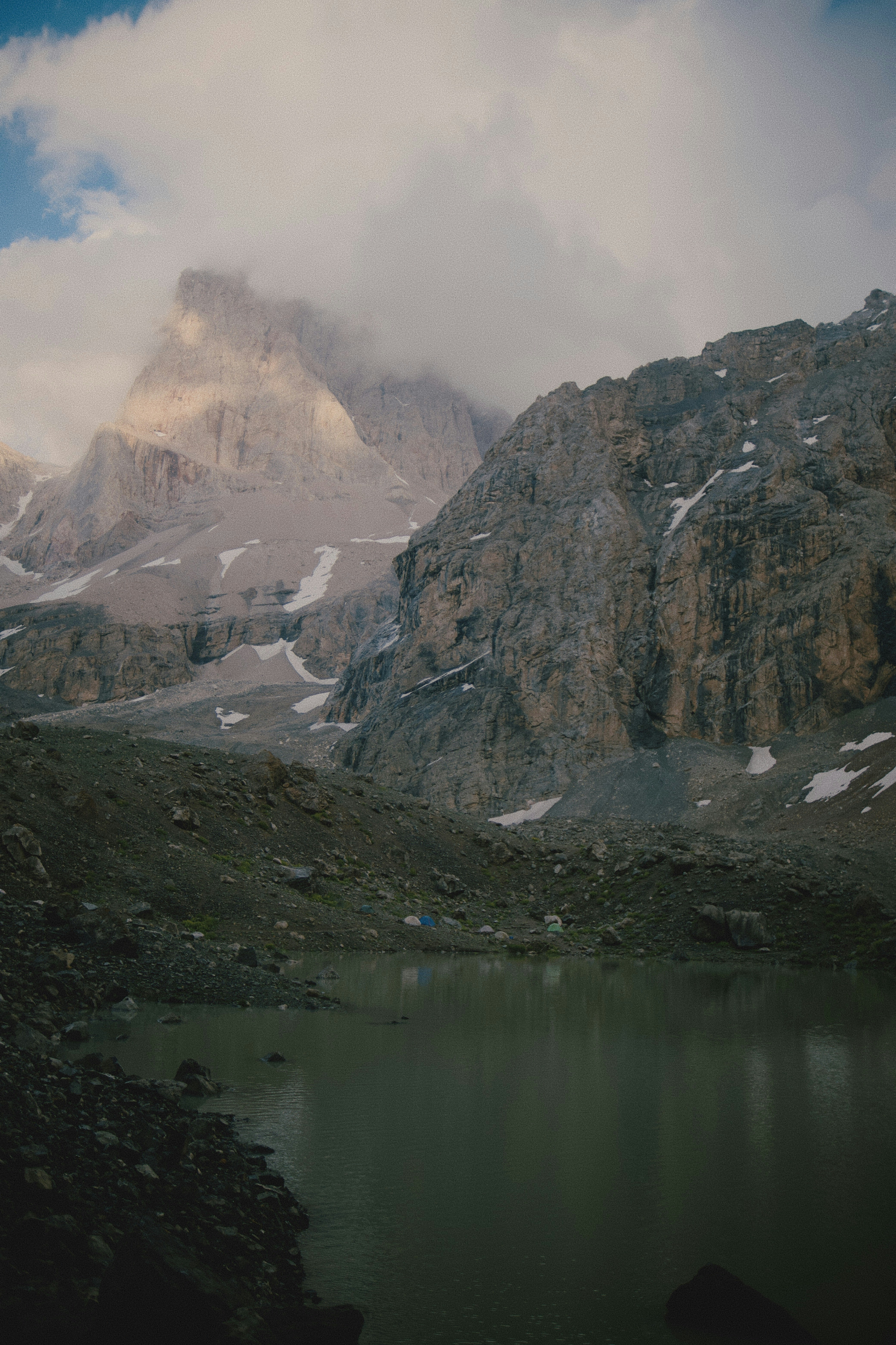 Cloud-kissed Peak Over a Quiet Alpine Tarn
