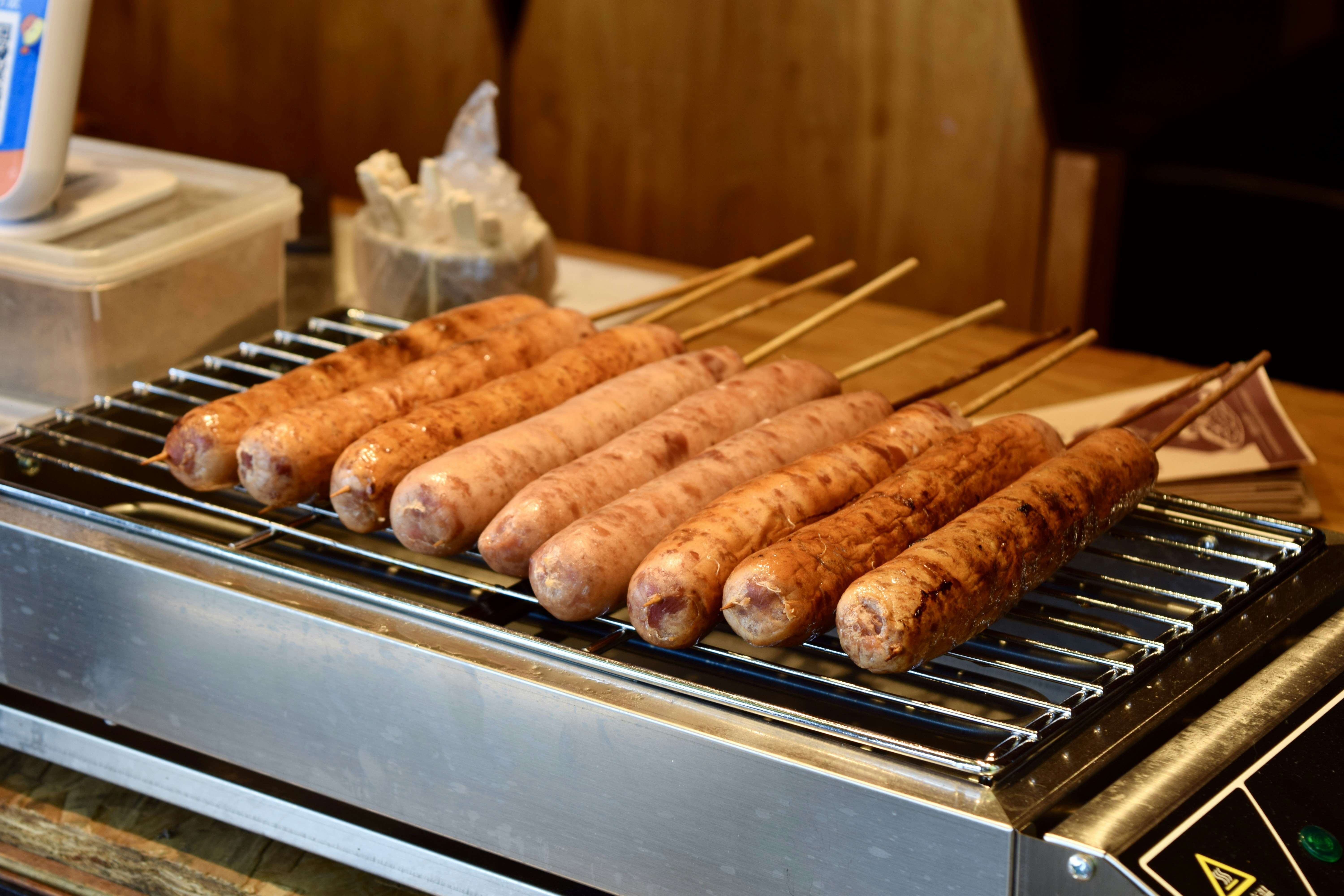 Skewered Sausages on a Stainless Grill