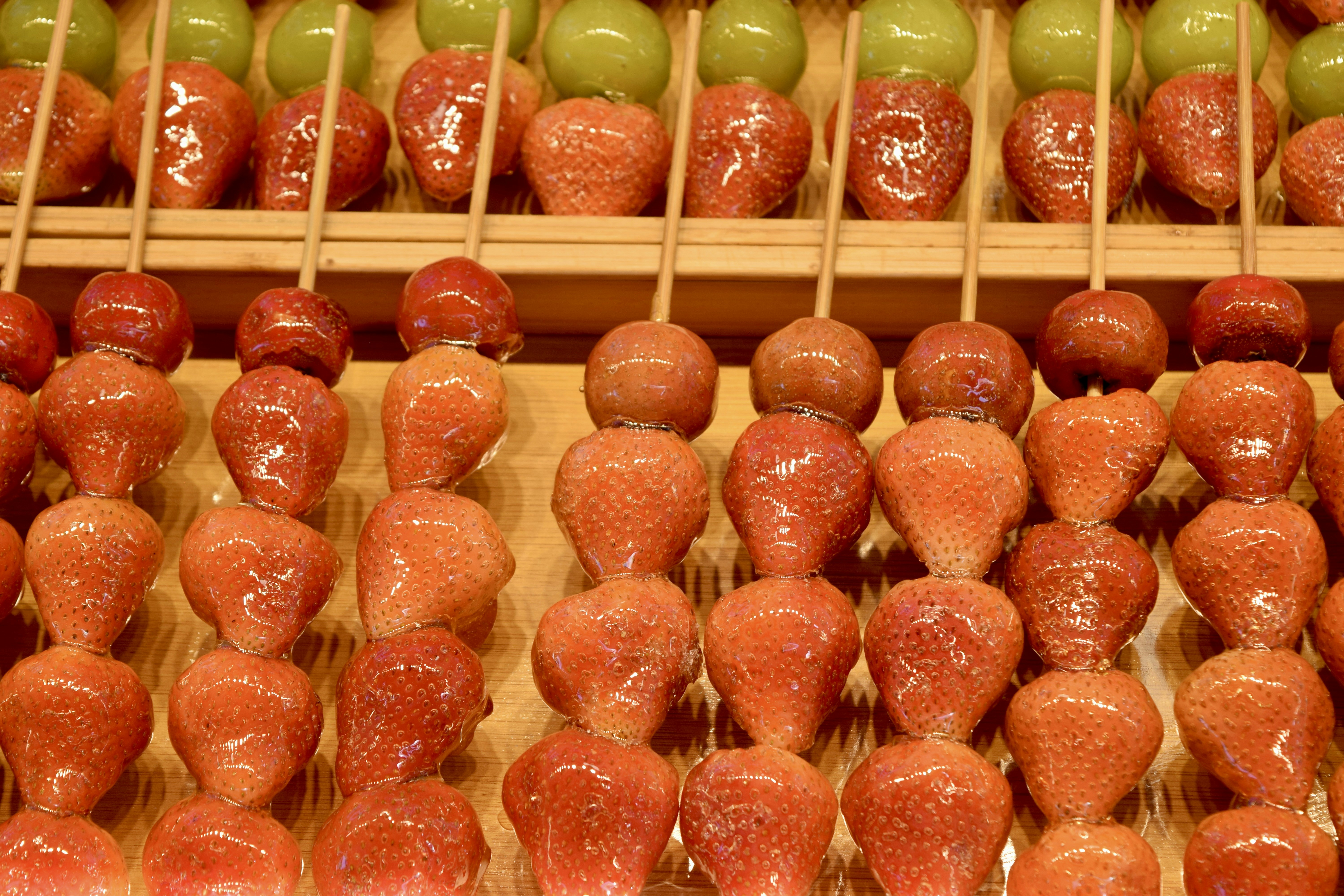 Candy Skewers: Rows of Orange Sugared Treats in a Wooden Display