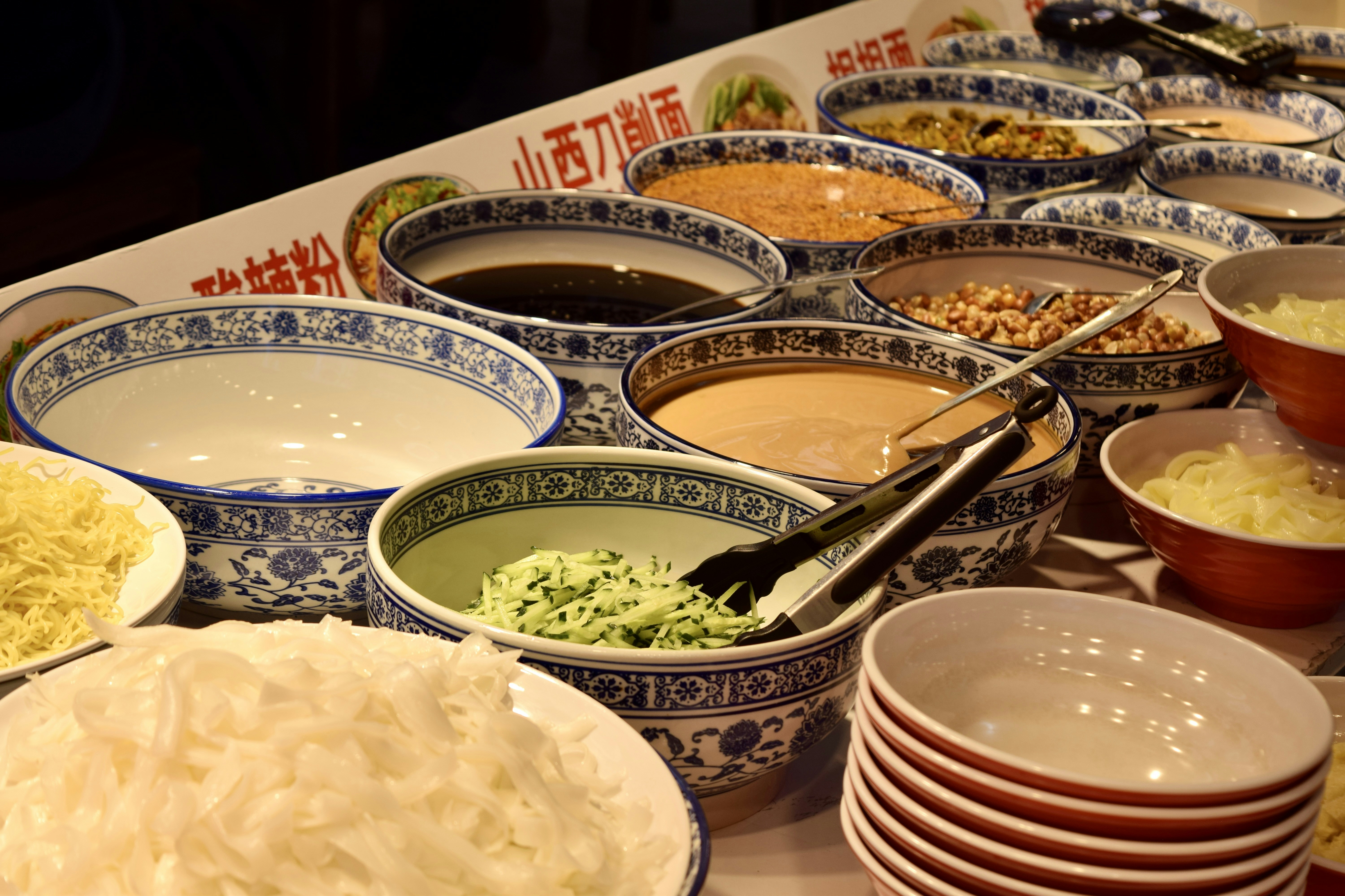 A Row of Sauced Bowls: Centerstage Delicacies on a Chinese Buffet