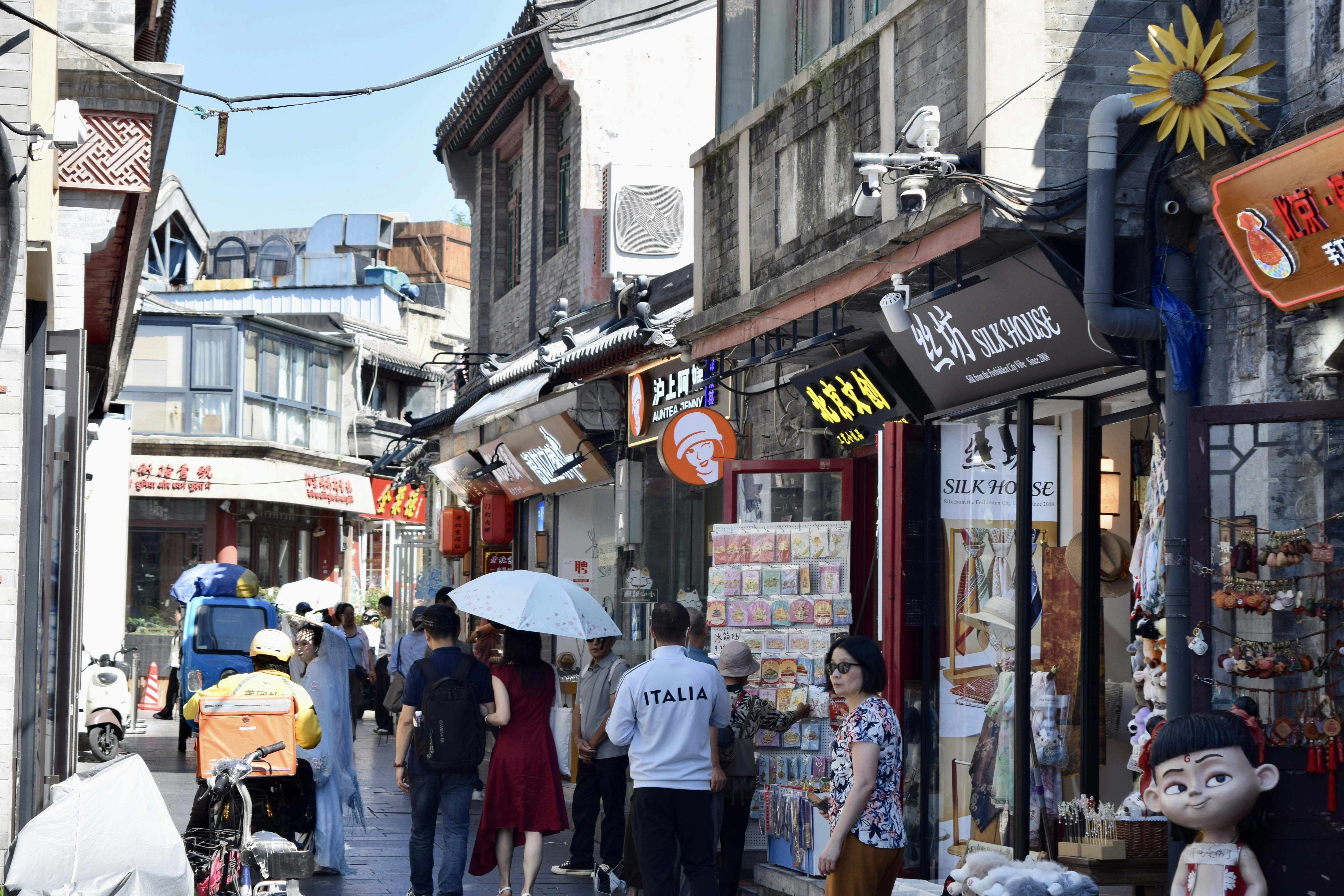 Sunlit Lane of Colorful Shops