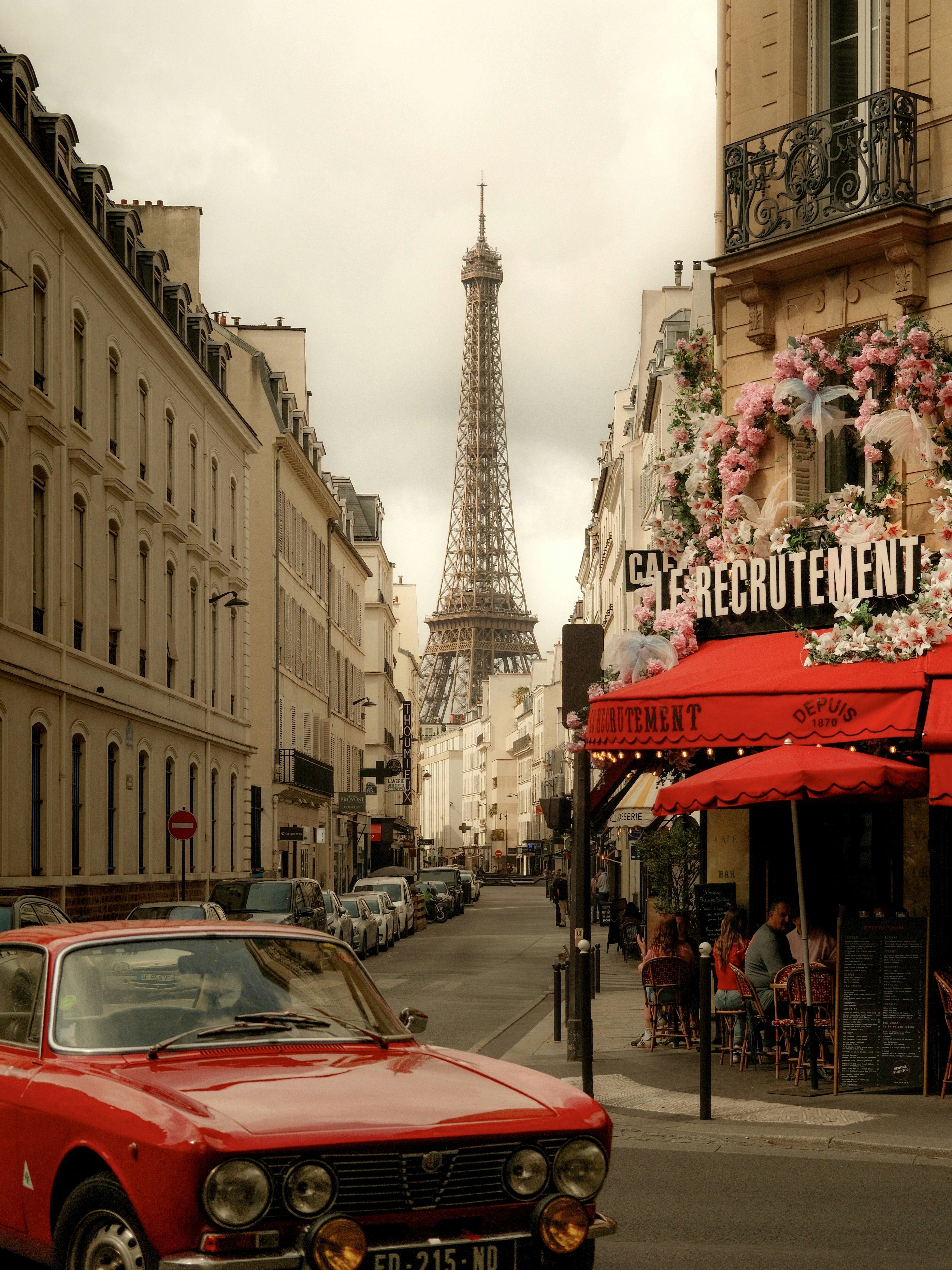 Parisian Street Serenade: The Eiffel Tower Framed by Café Façades