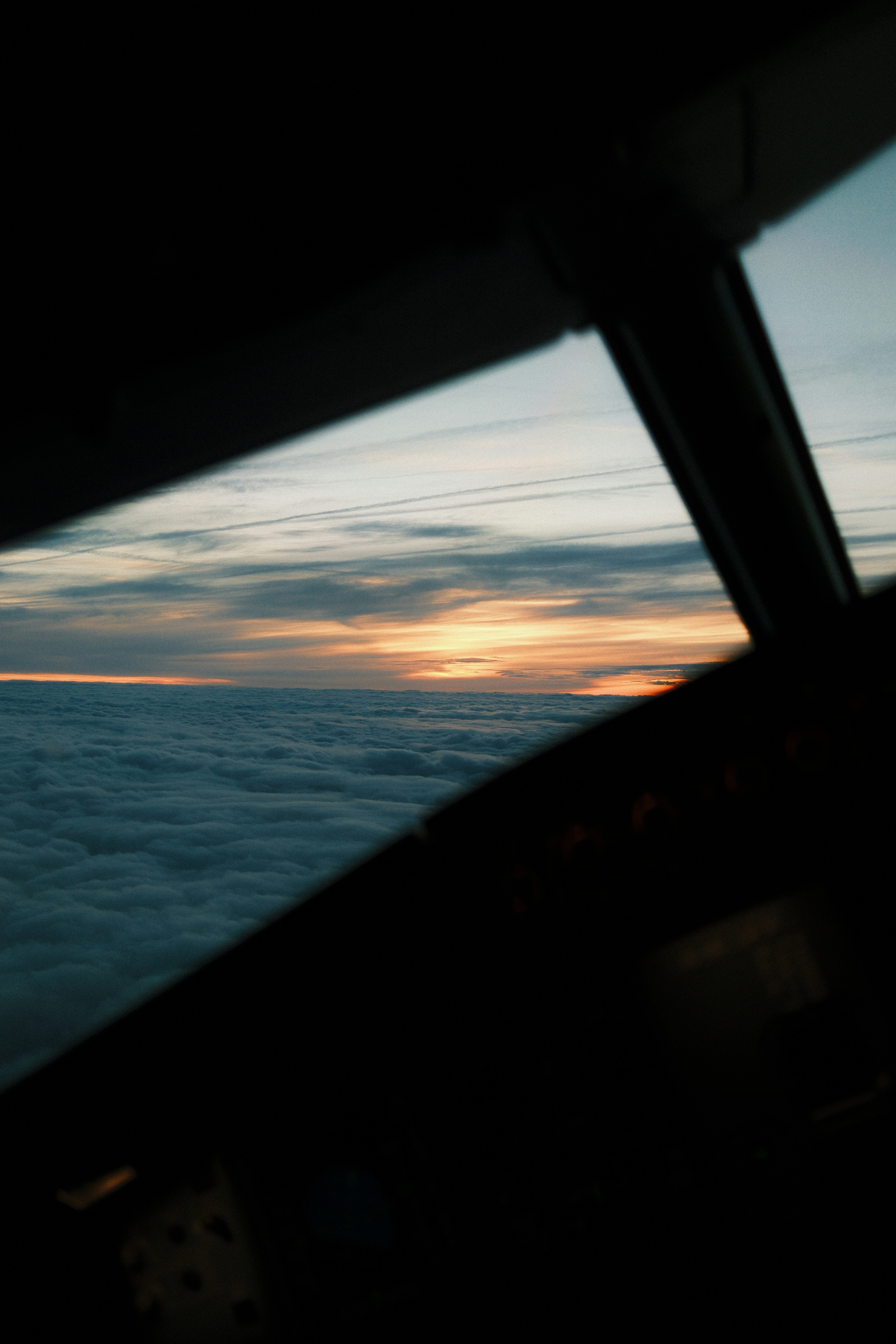 Sunset Break Over the Clouds: aircraft cockpit view