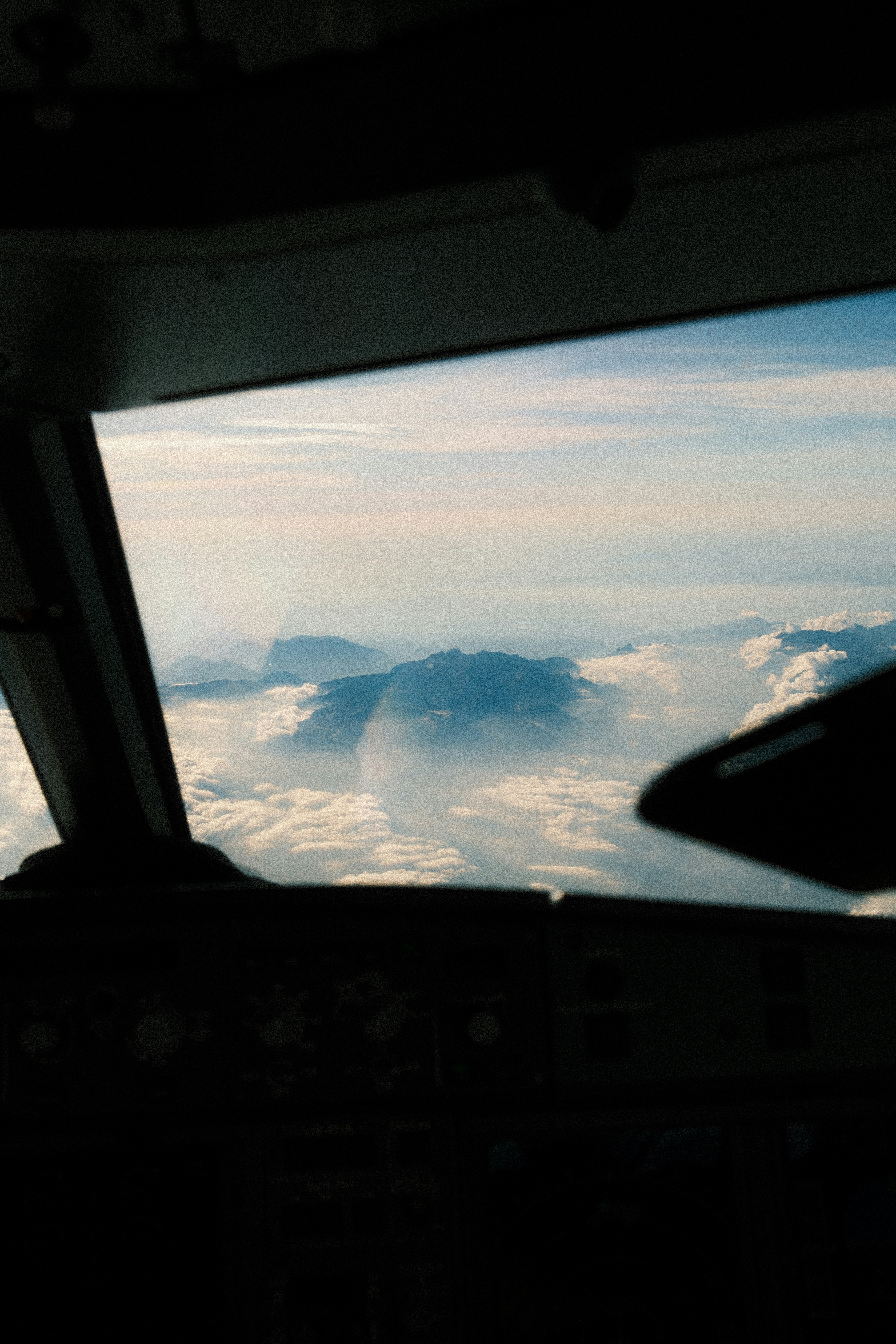 Skybound Cockpit: Aerial Peaks Through the Window