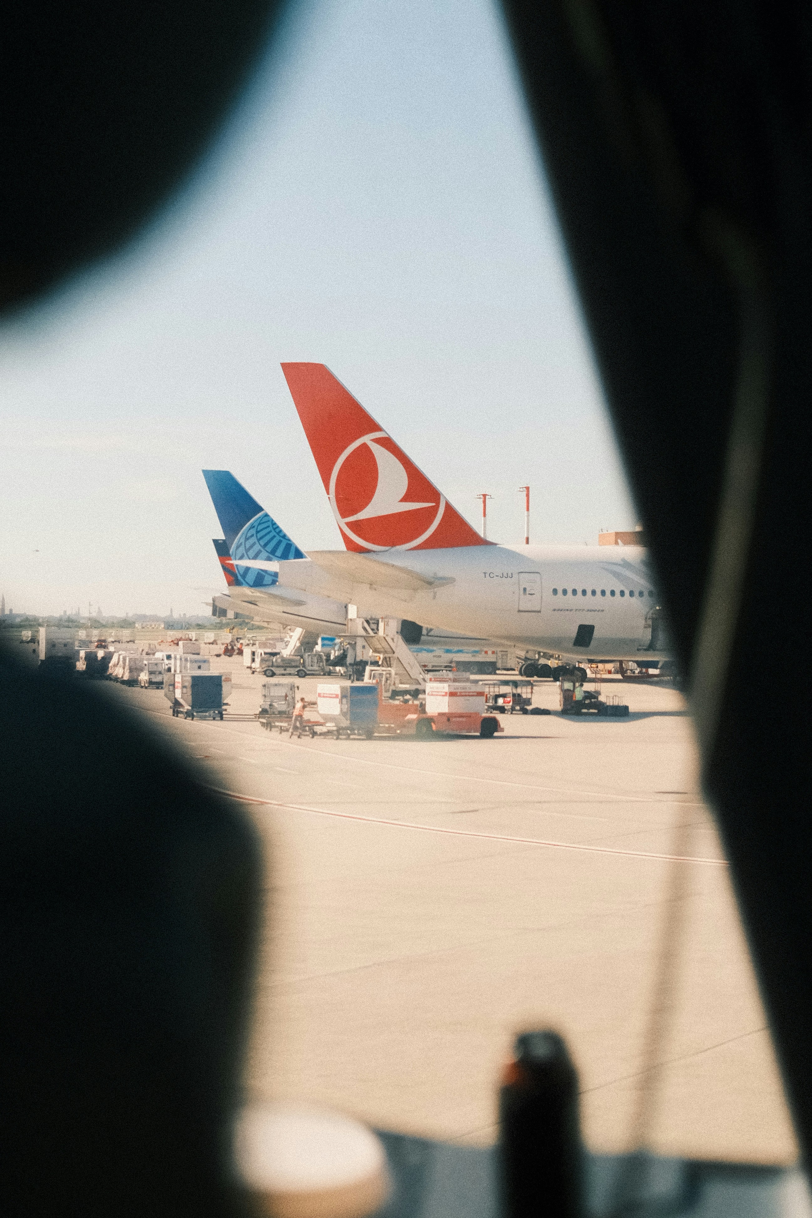 Tail End of a Split‑Frame: Airliners Stacked at the Gate