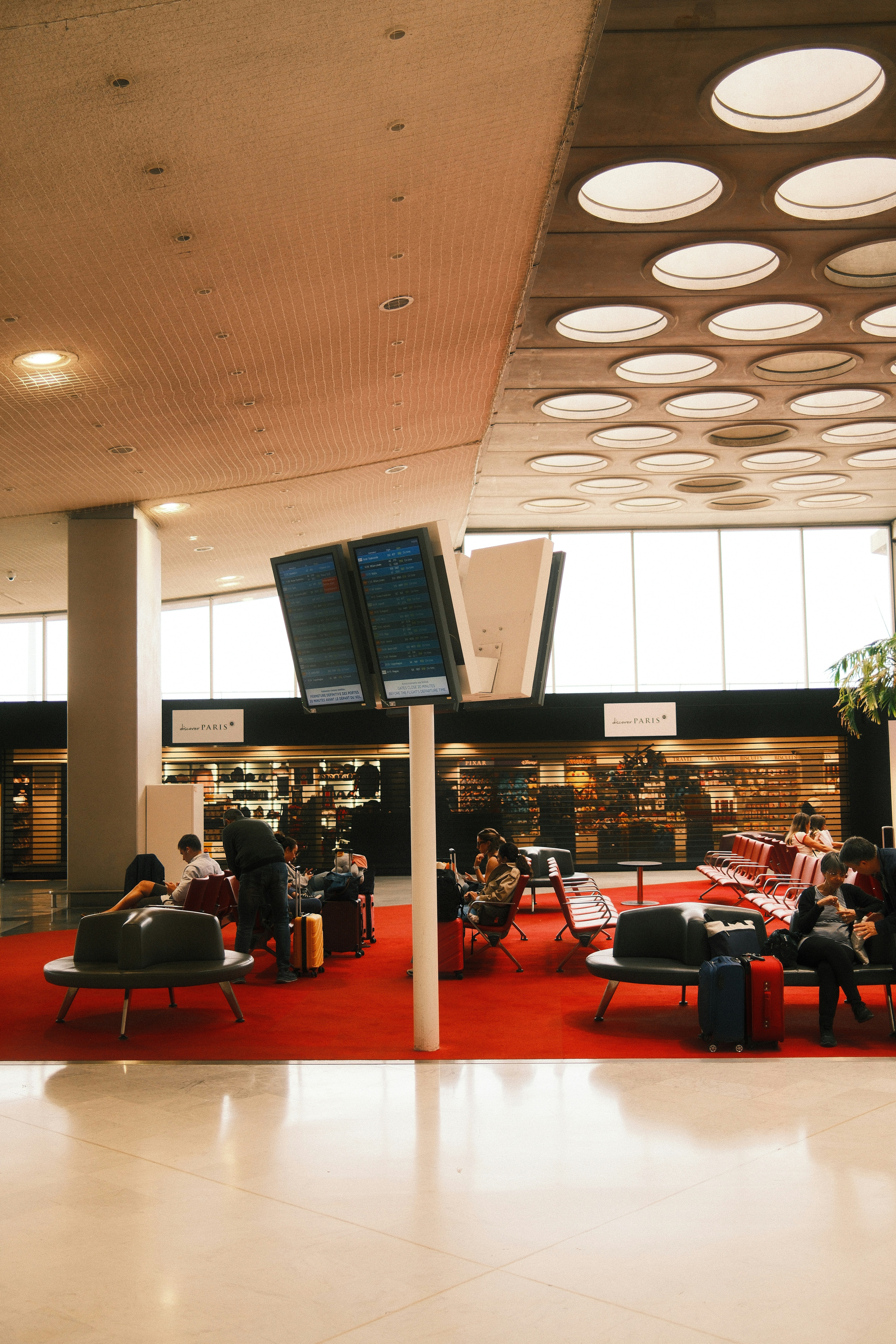 Terminal Lounge Confluence: People at Rest Under Circular Ceiling Umbrellas