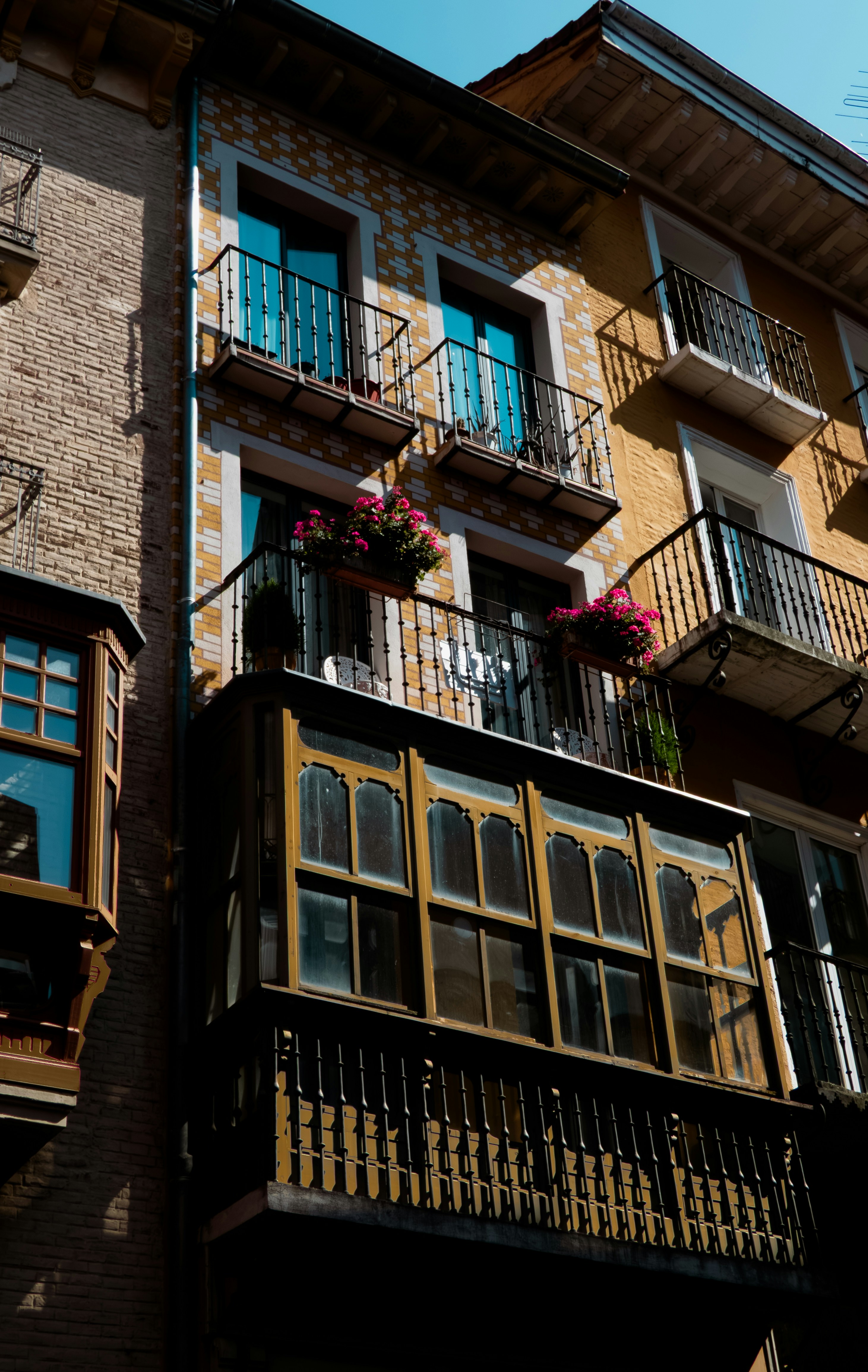 Balconies in Morning Light: A Facade of Colorful Grains and Glass