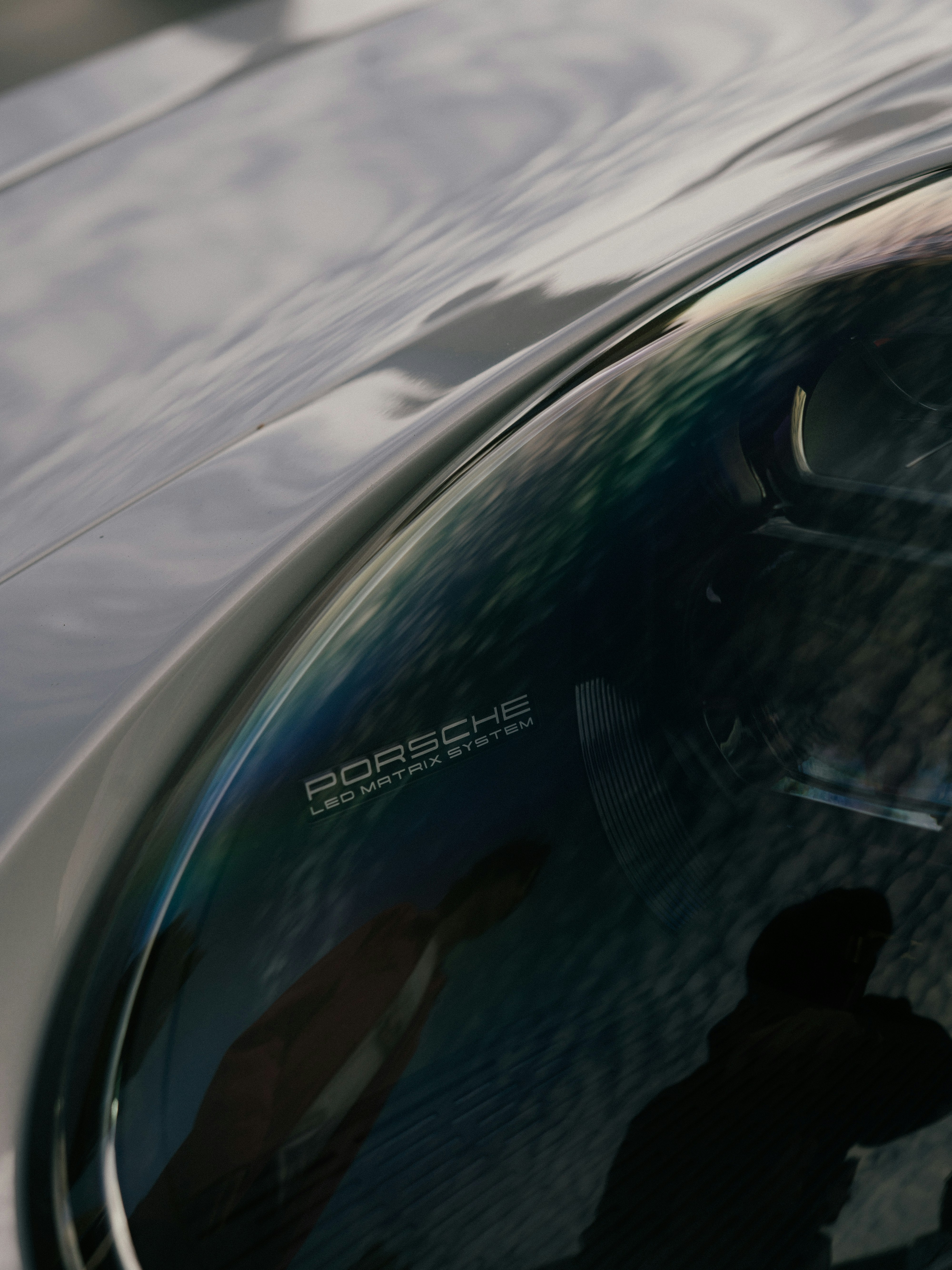 Porsche Reflection in a Car Window: Hidden Brand at the Edge of Curves