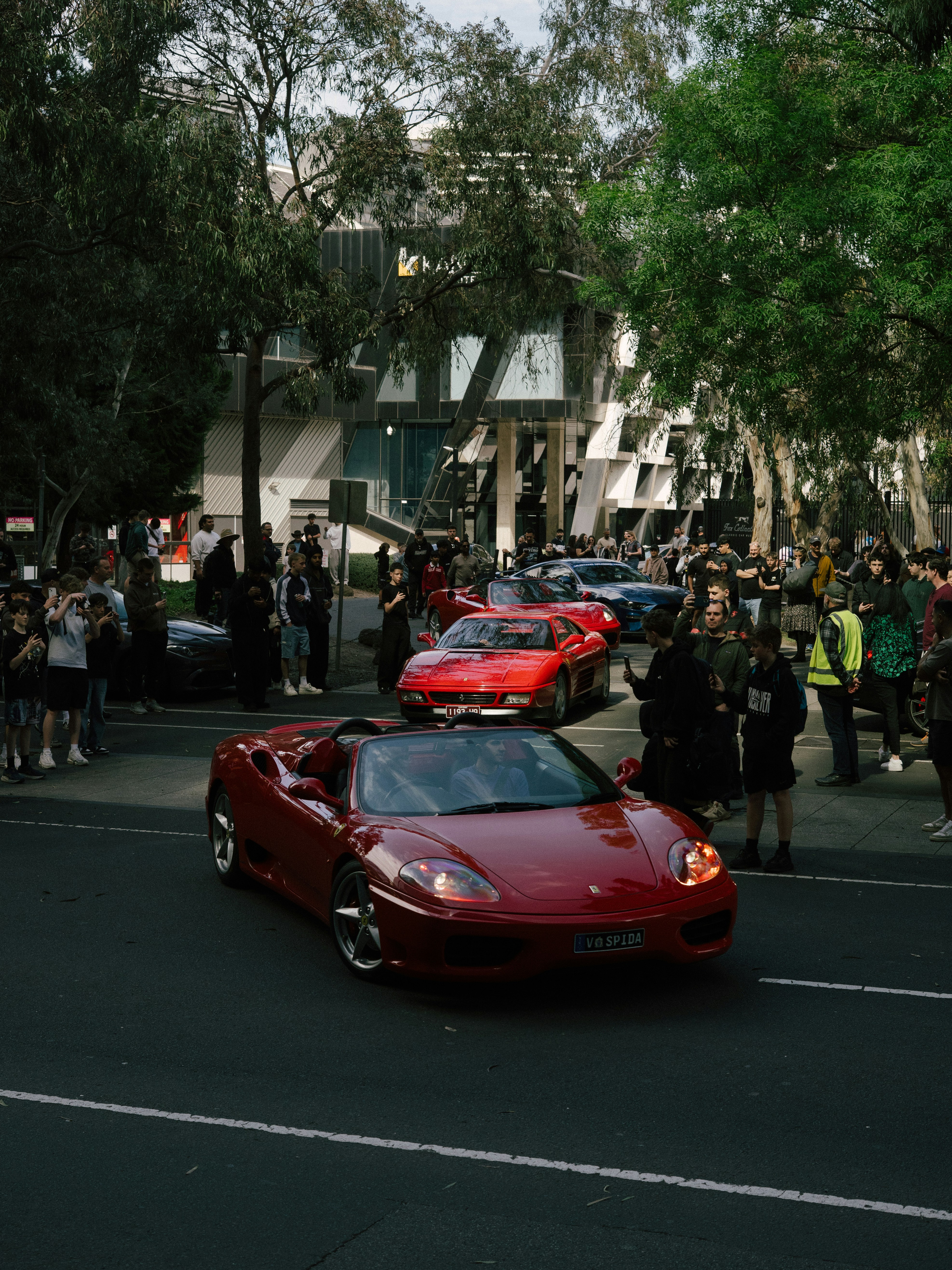 Red Line: A Convertible Parade on a City Street