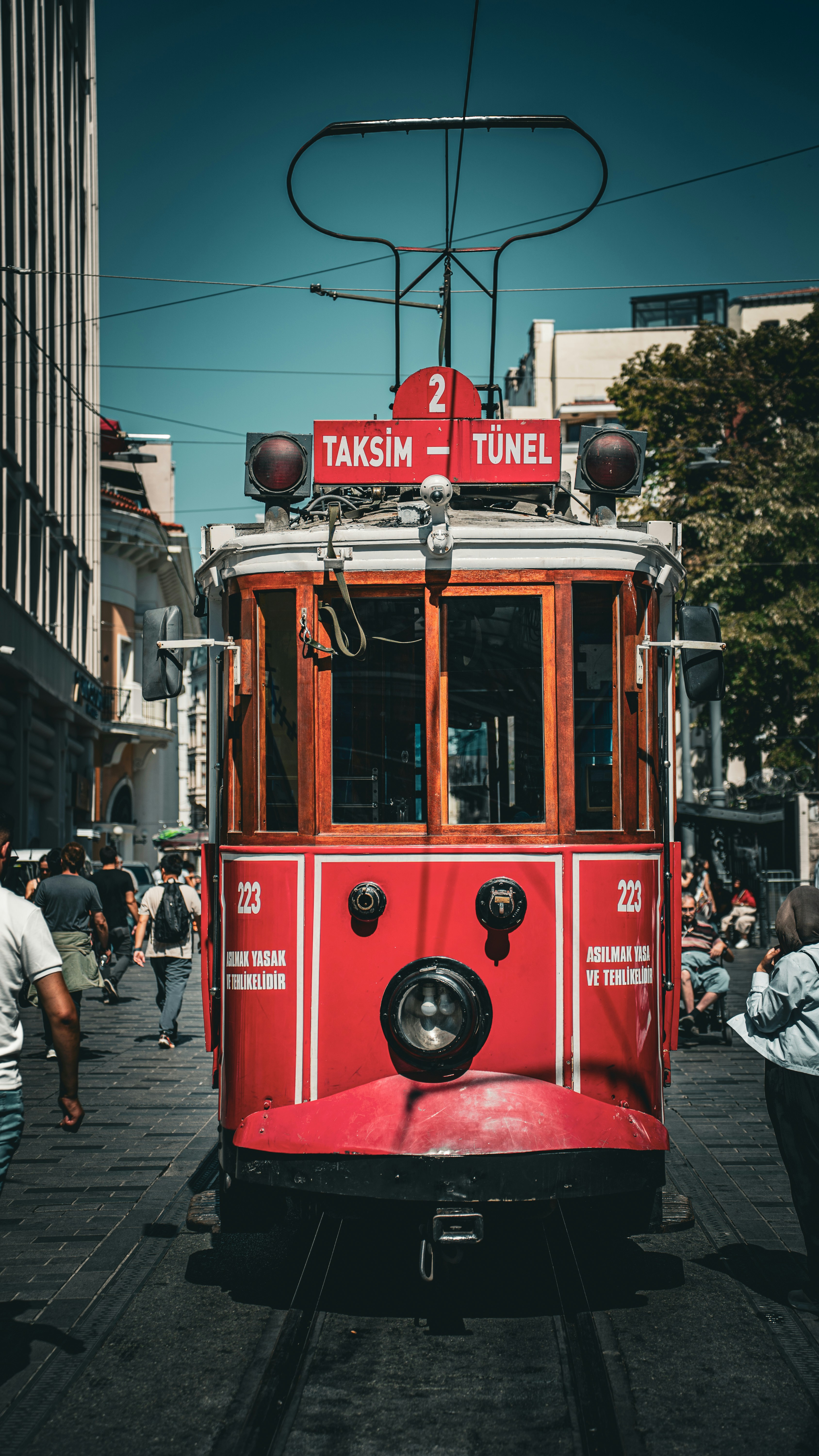Old City Tram: Red Carriage at the Heart of a Busy Street