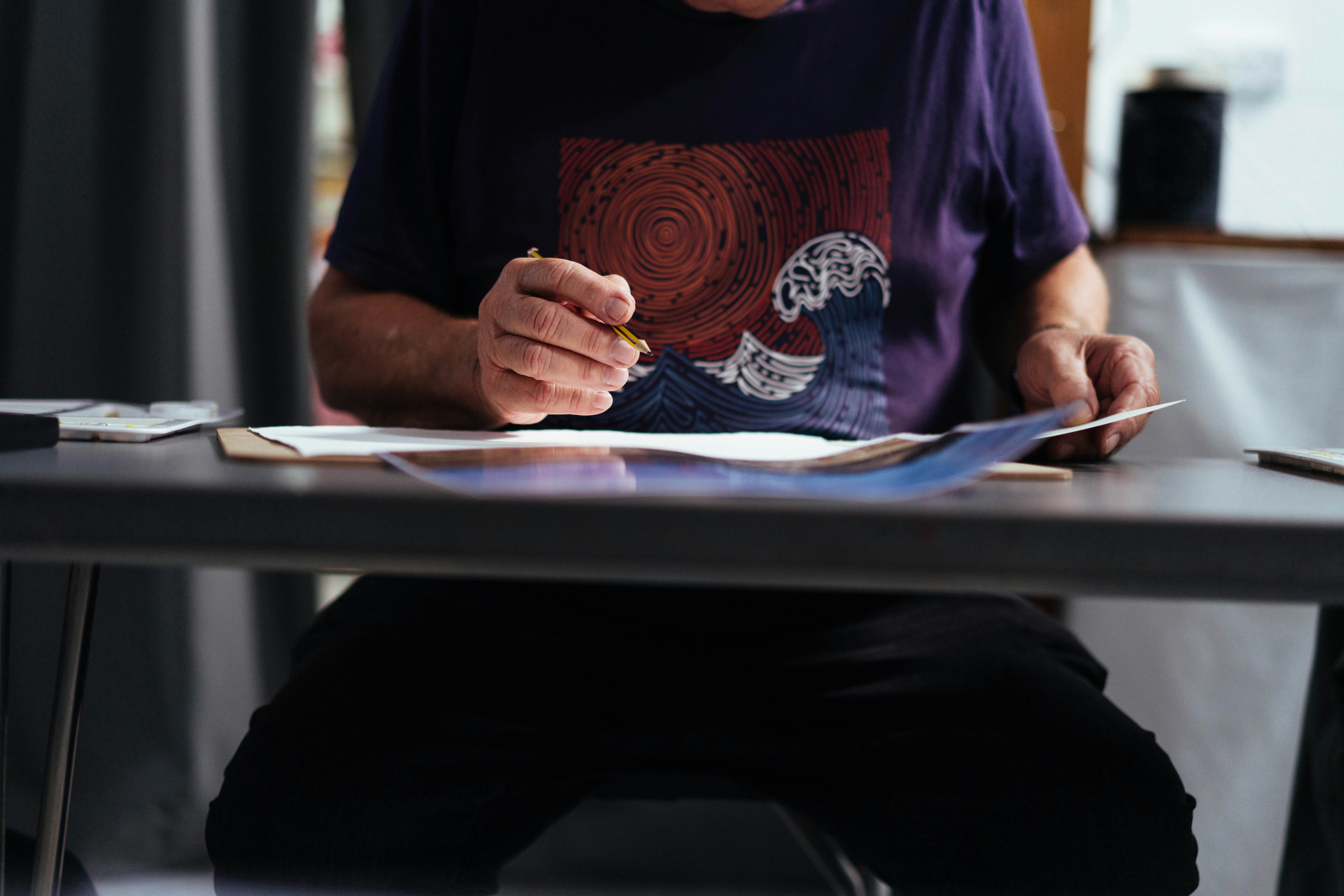 Hands in Focus: A Quiet Workspace Unfolds Across a Desk