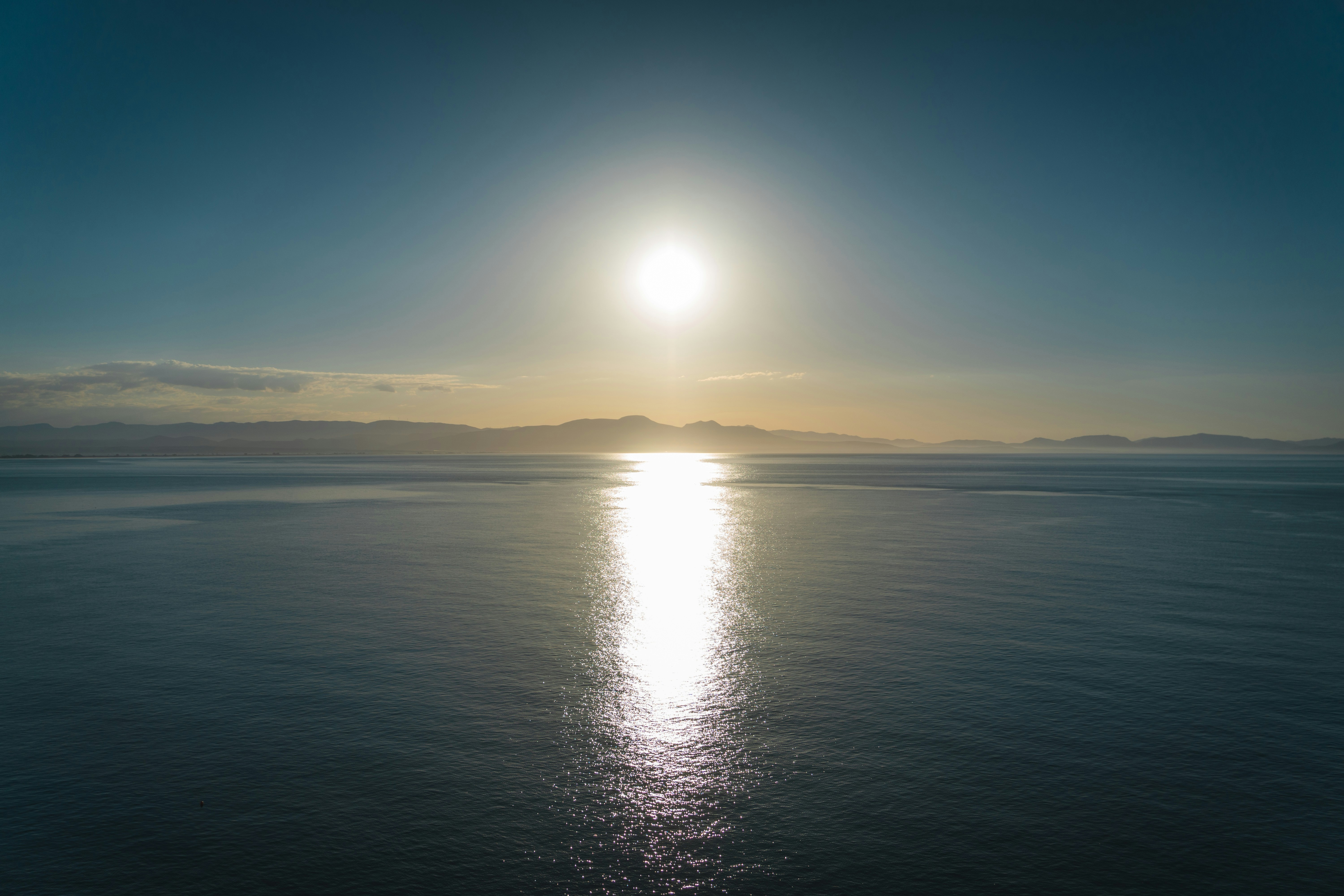 Sunlit Path Across a Calm Ocean