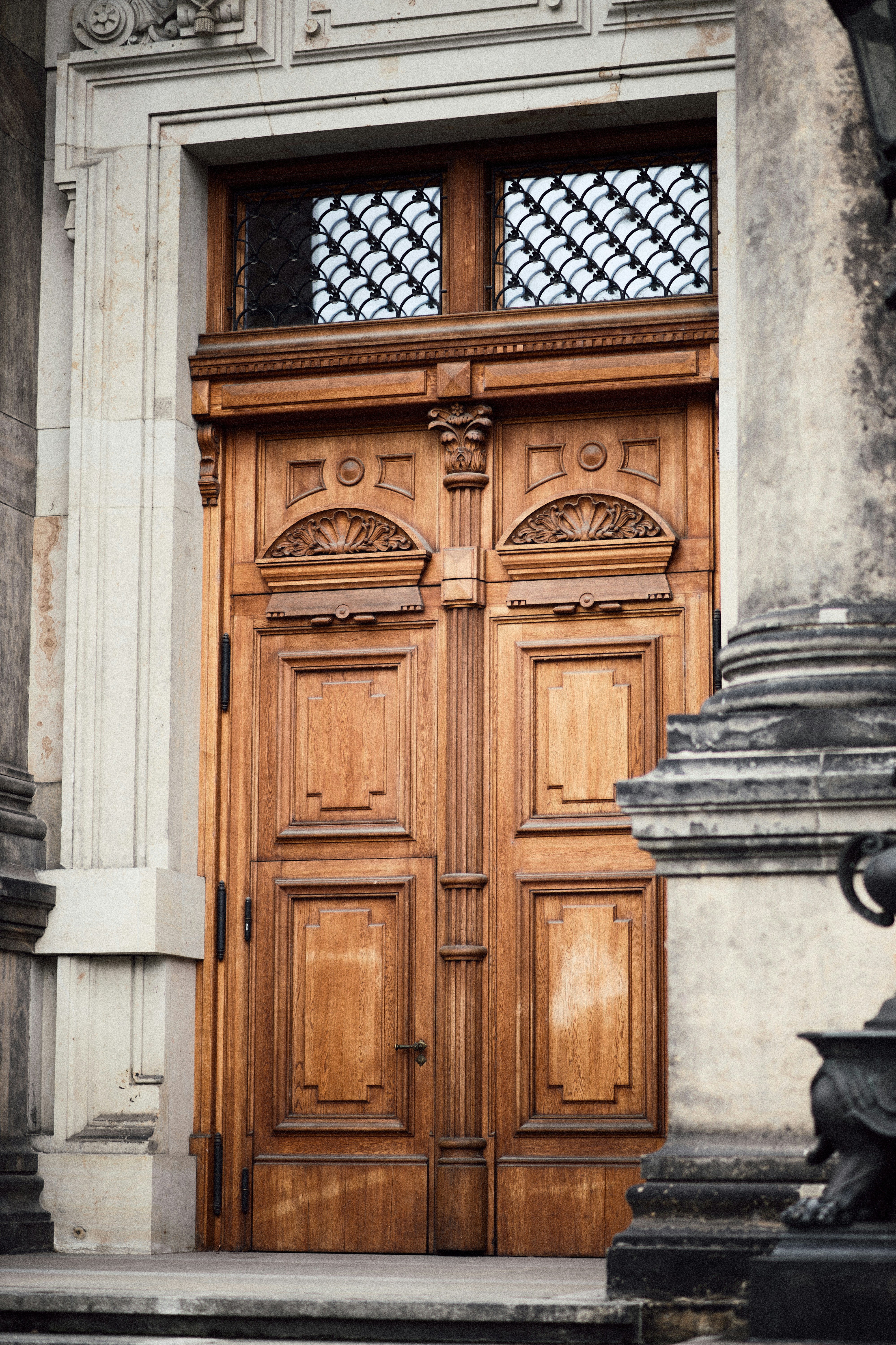 Ornate Timber Doorway Framed by Classical Stone Architecture