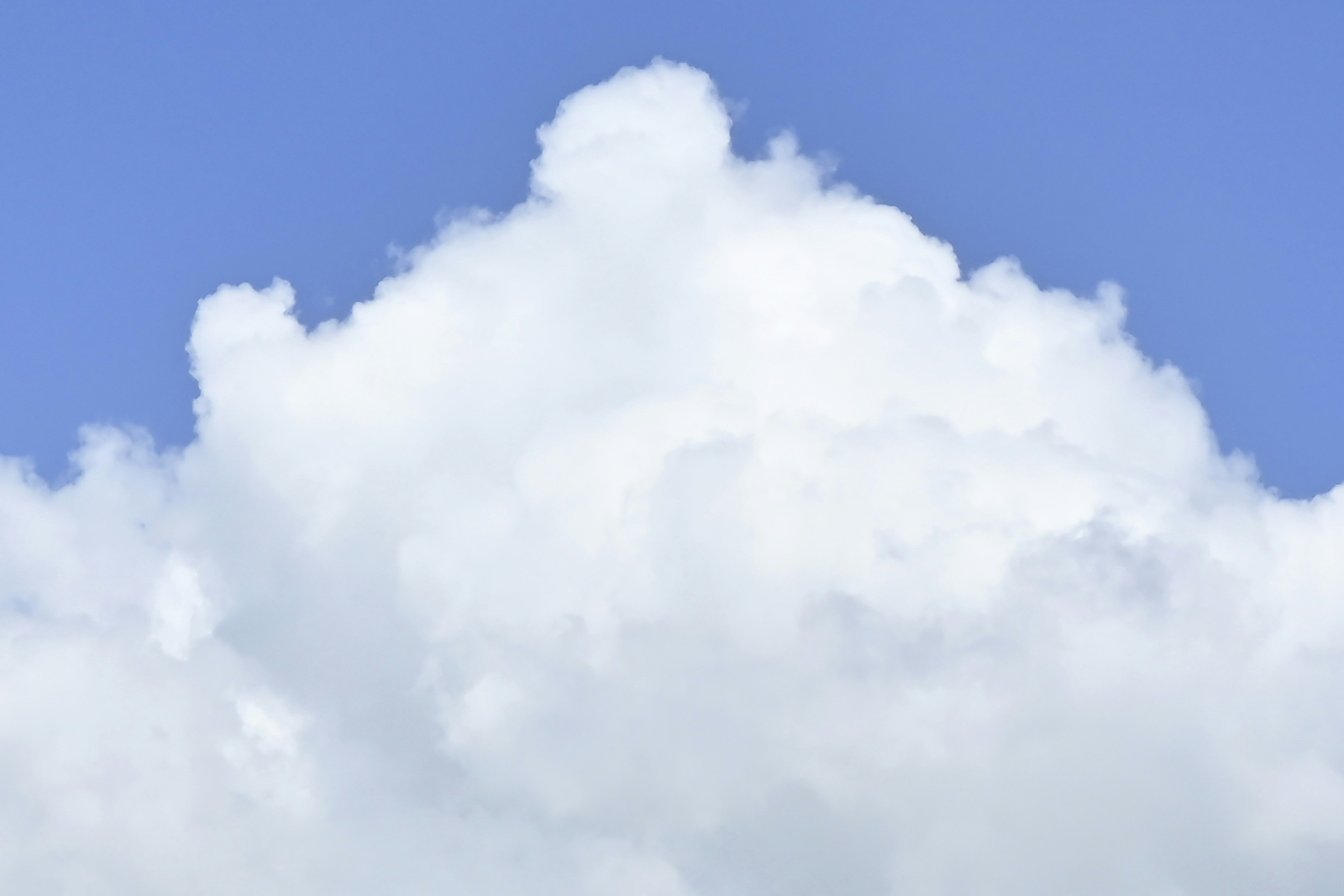 Cloud Crown: A Pillar of Sky Above a Calm Horizon