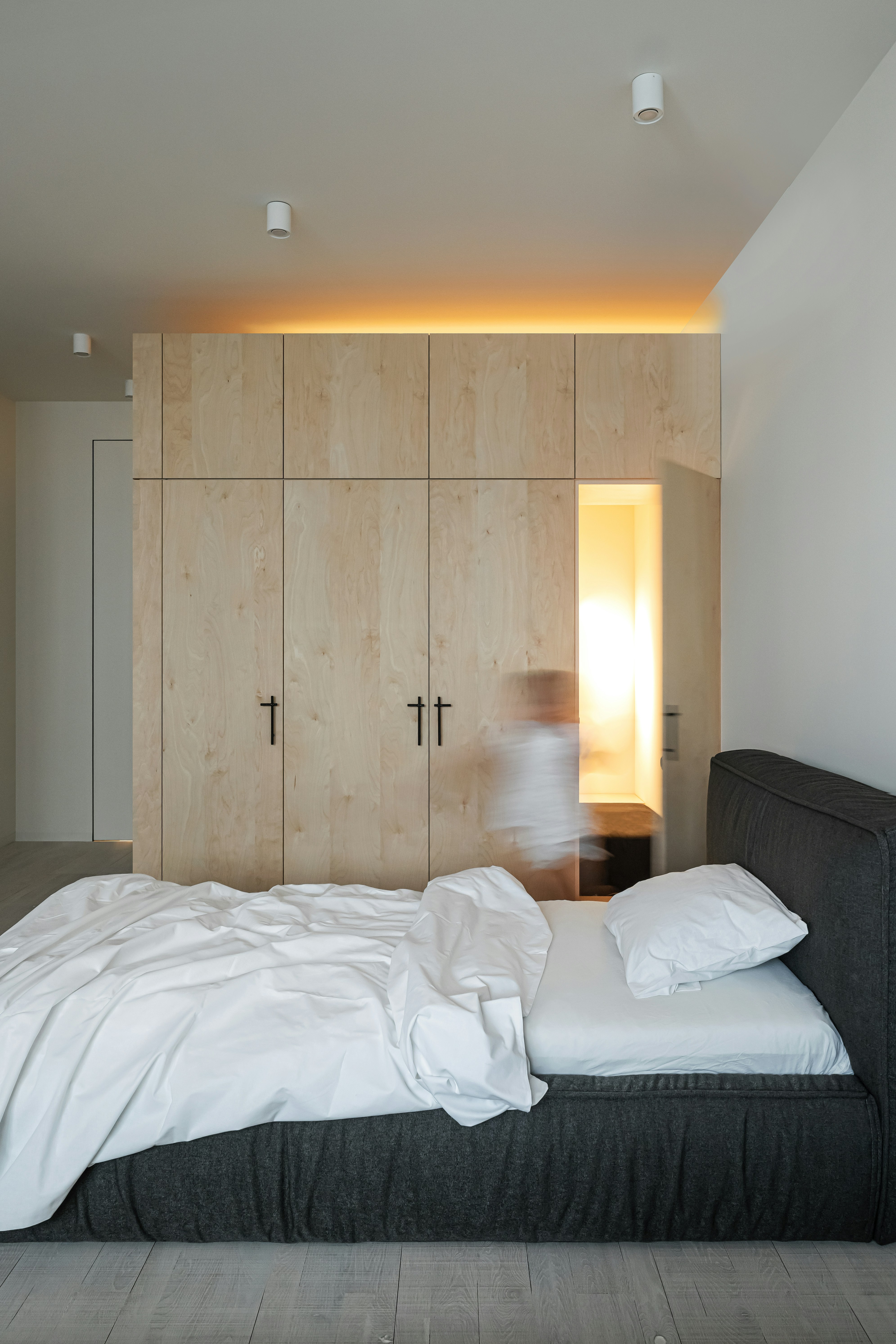 Minimalist Bedroom with Timber Wardrobe and Soft Glow